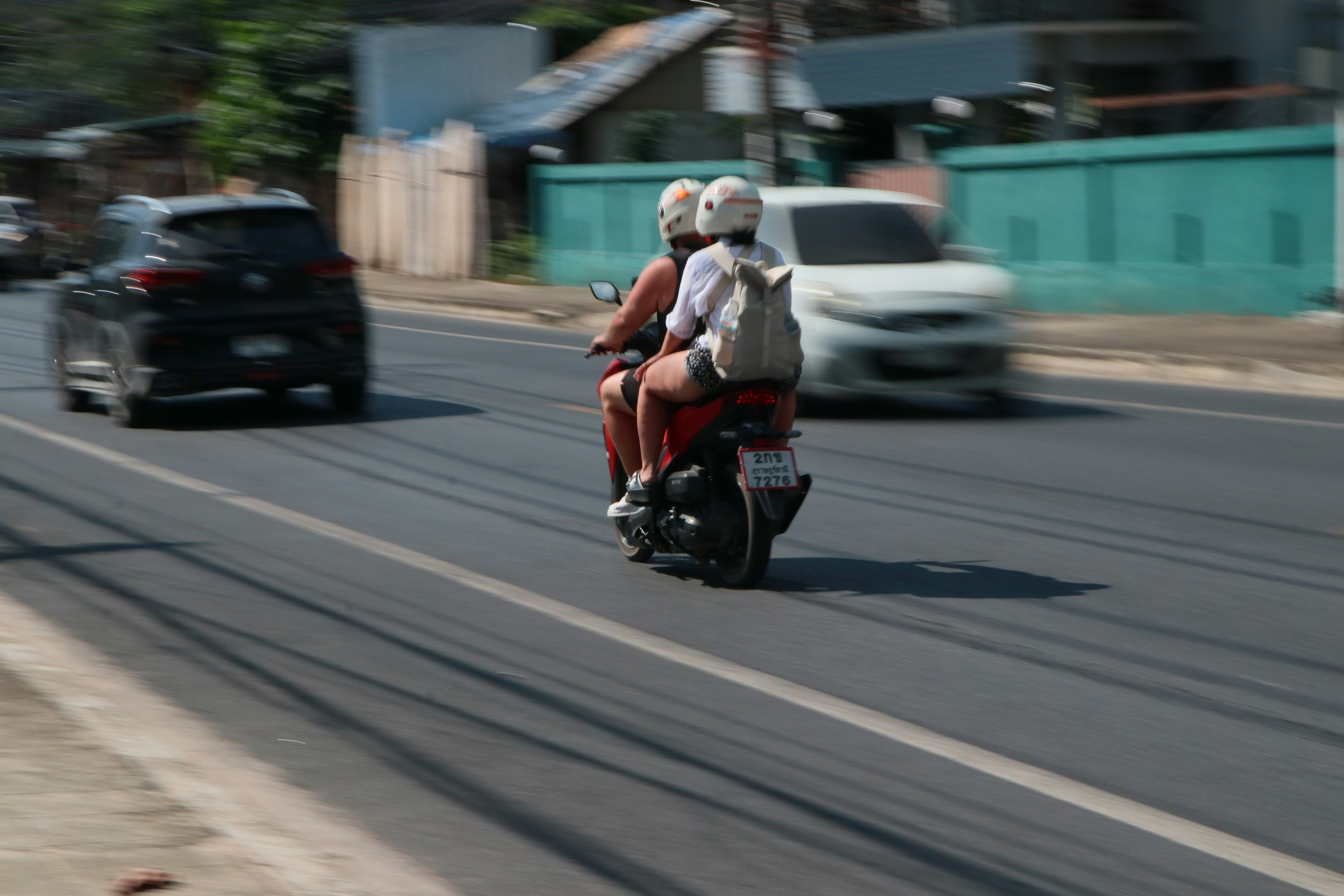 Scooter Pair on a Sunlit Urban Road