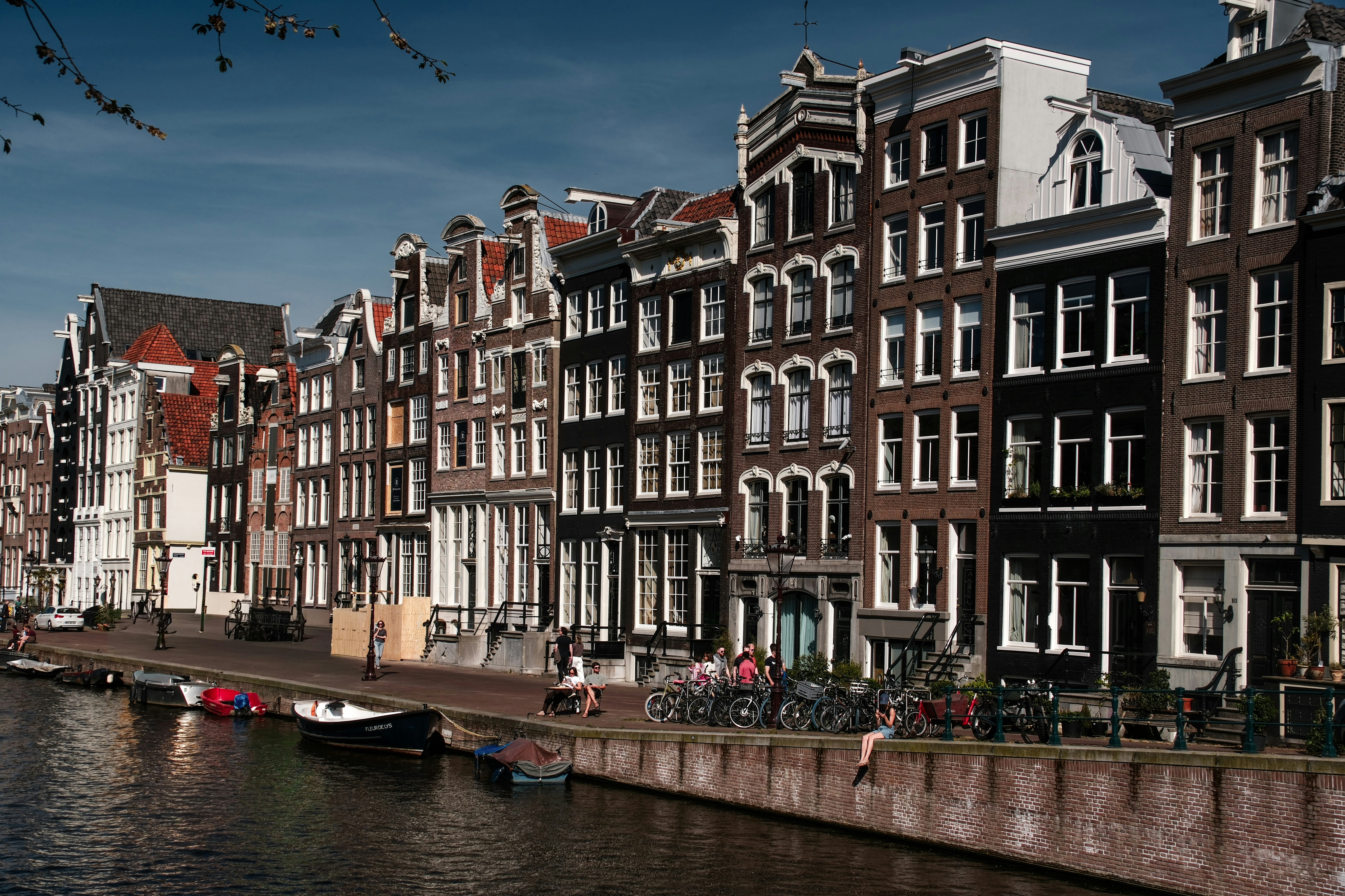 Canal-side Row: Historic Facades, Bikes, and Boats in a Dutch-Eleven Scene