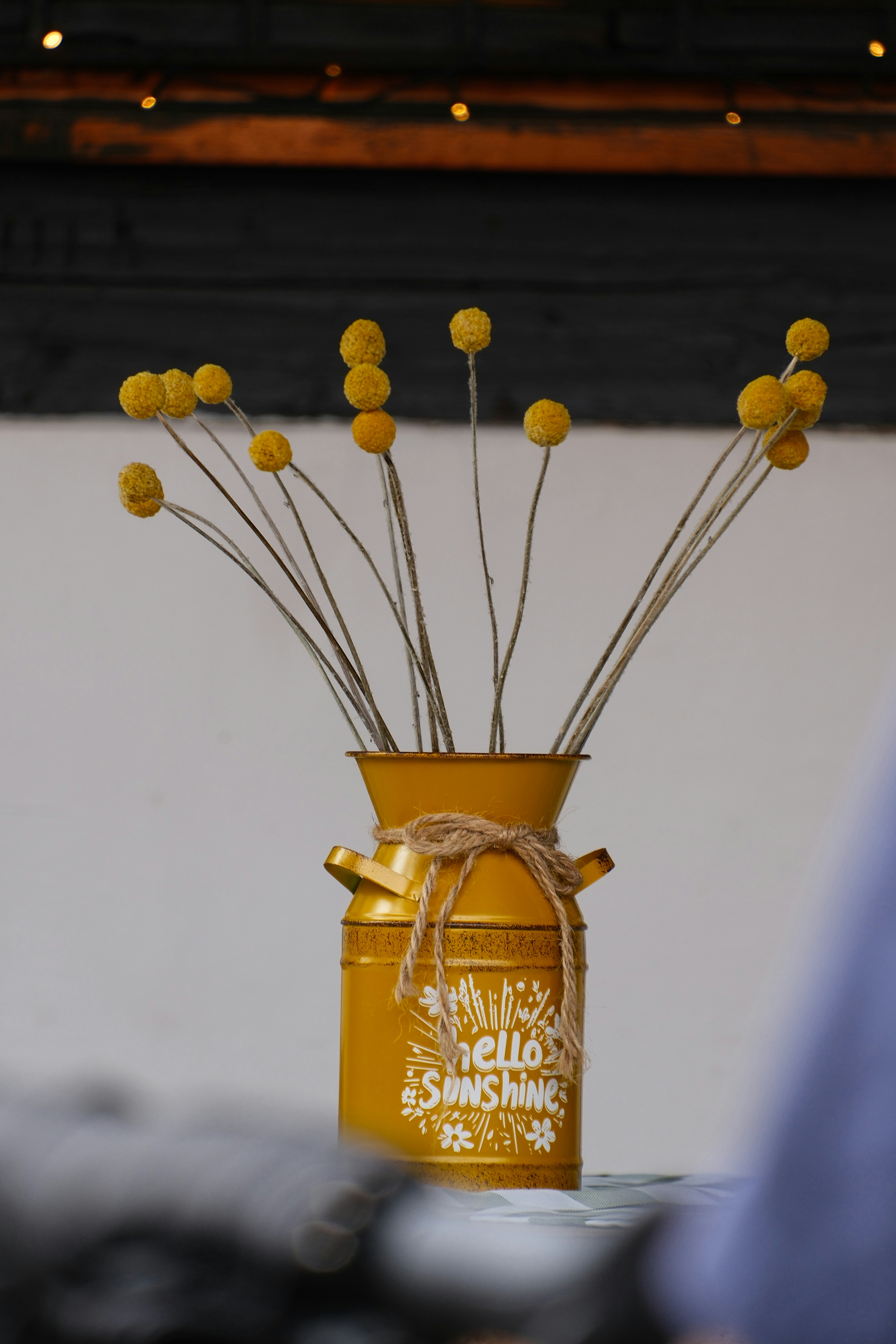 Yellow Vase of Dandelion-Like Stems: A Sunny Still Life in Soft Bokeh