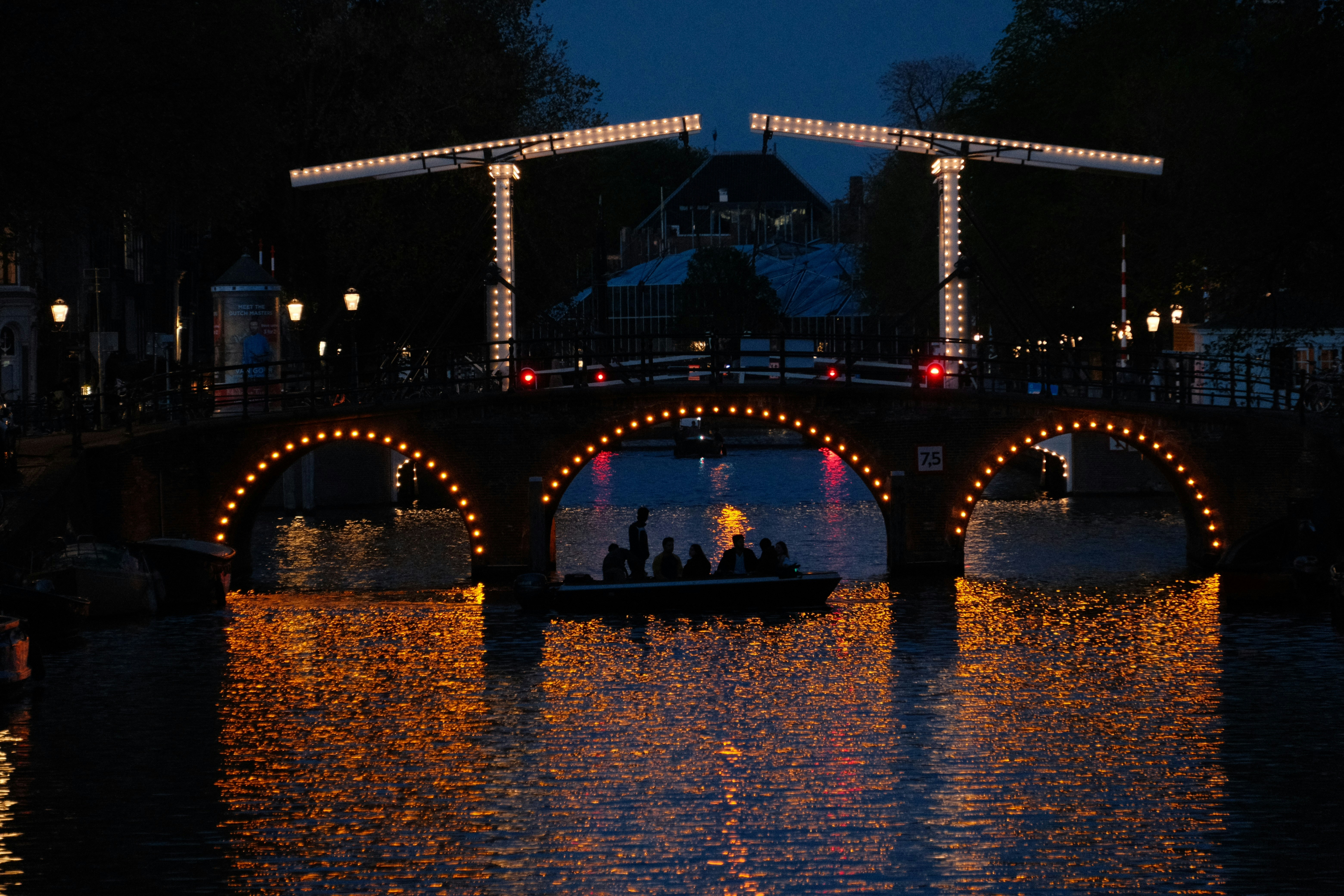Moonlit Bridge: Reflections and Silhouettes on the Canal