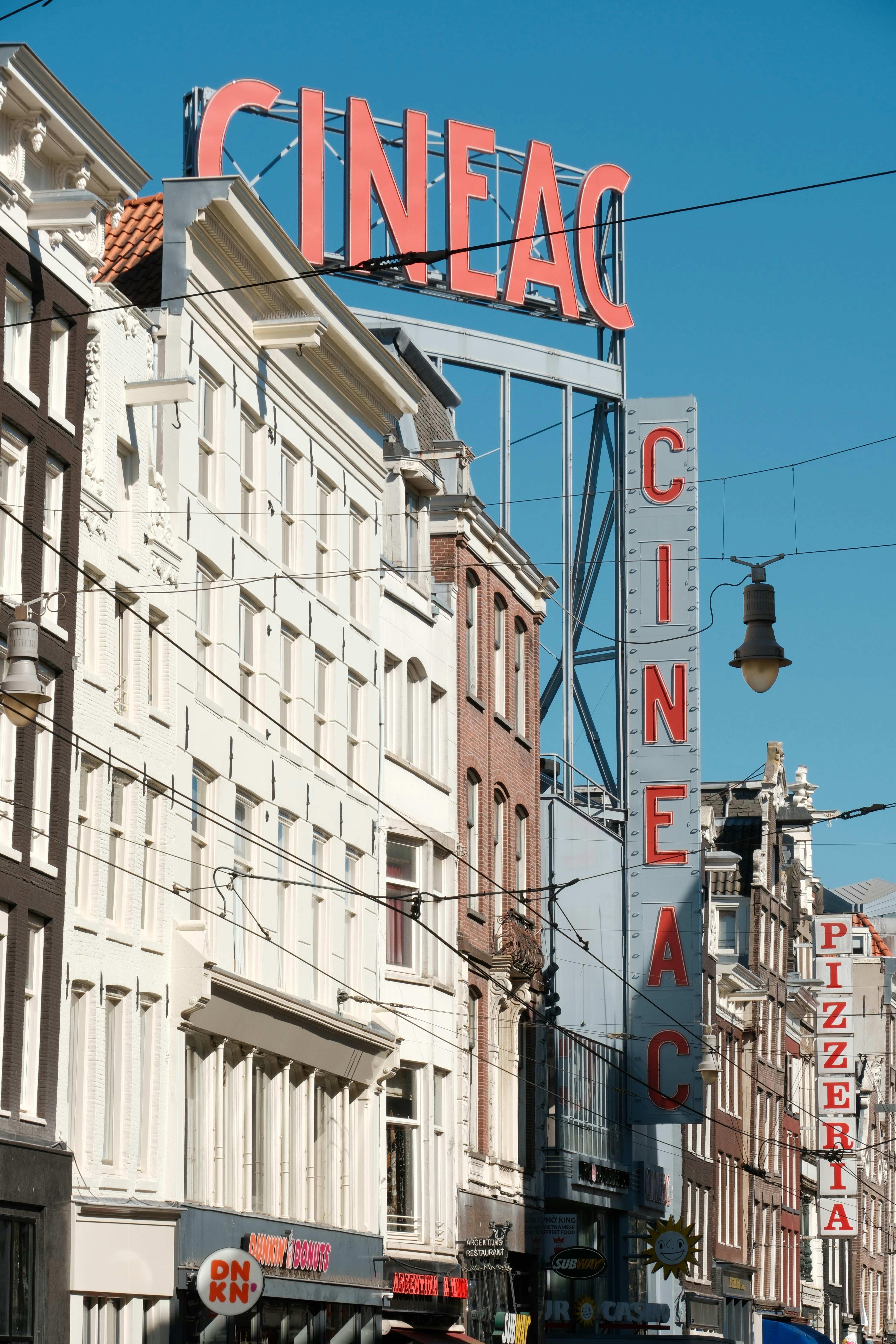Neon Signage Over a Historic European Street