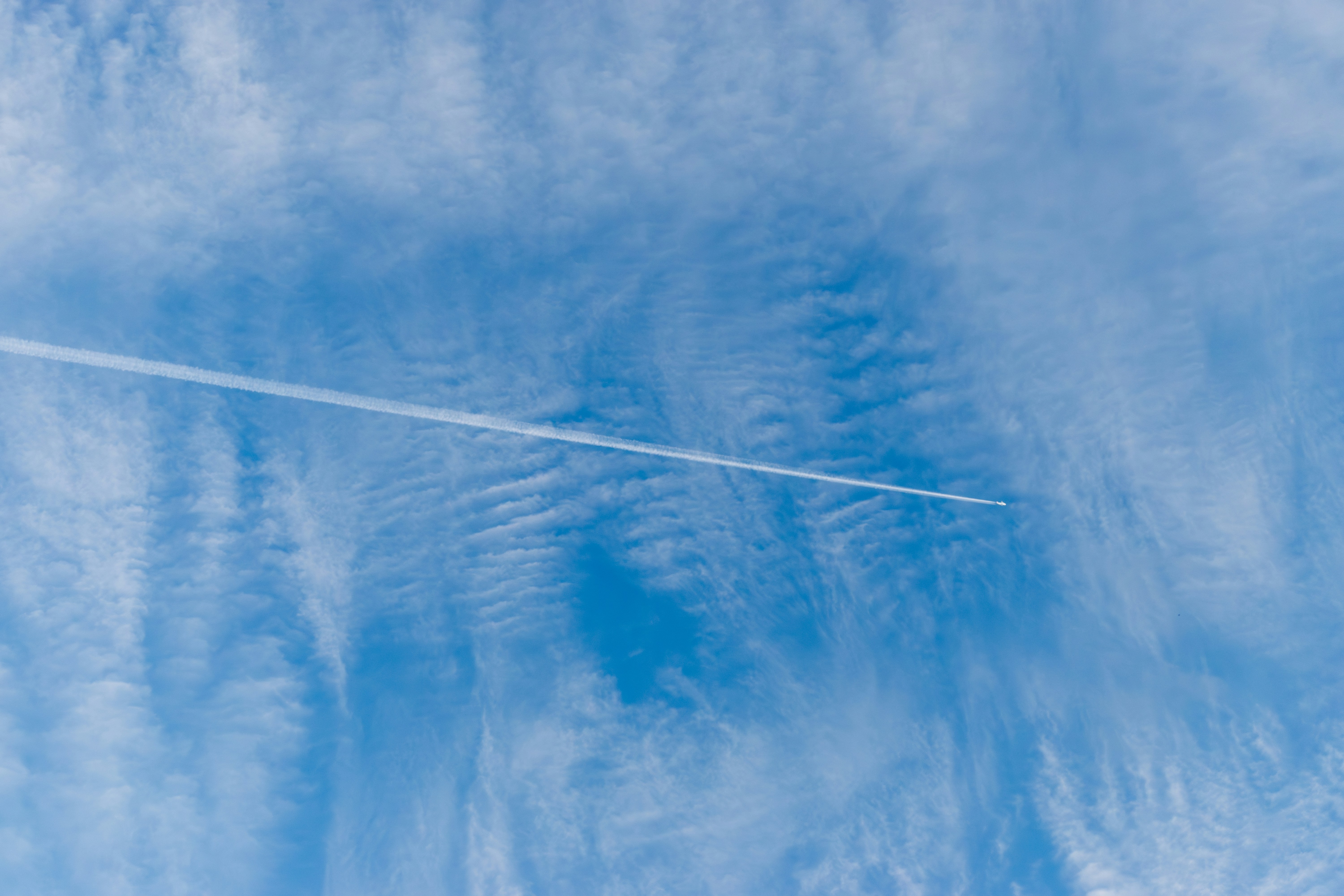 Jet Trail Across a Bright Sky