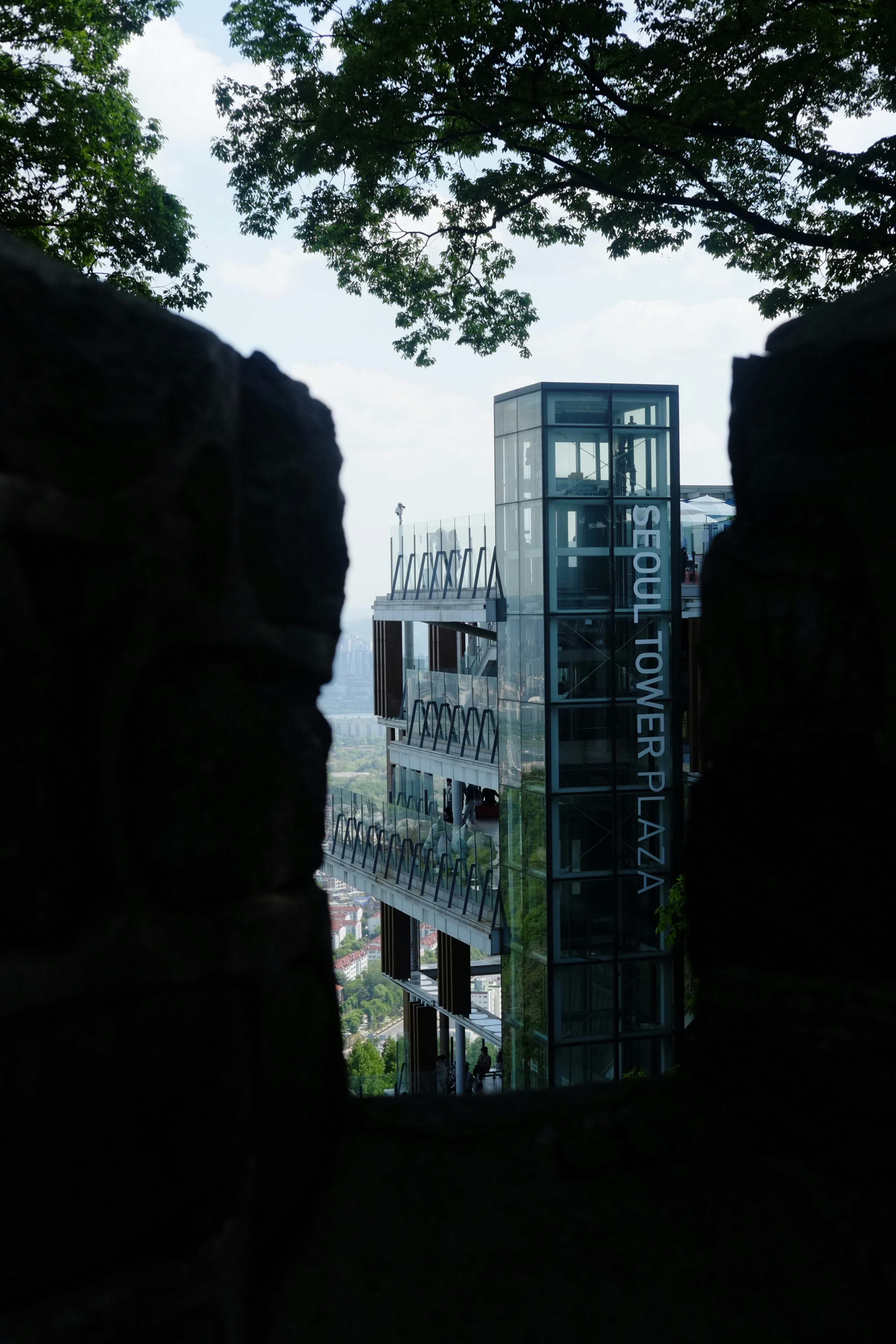 Tower Elevator Framed Between Treasures: A View Through the Window into a Modern Skybridge