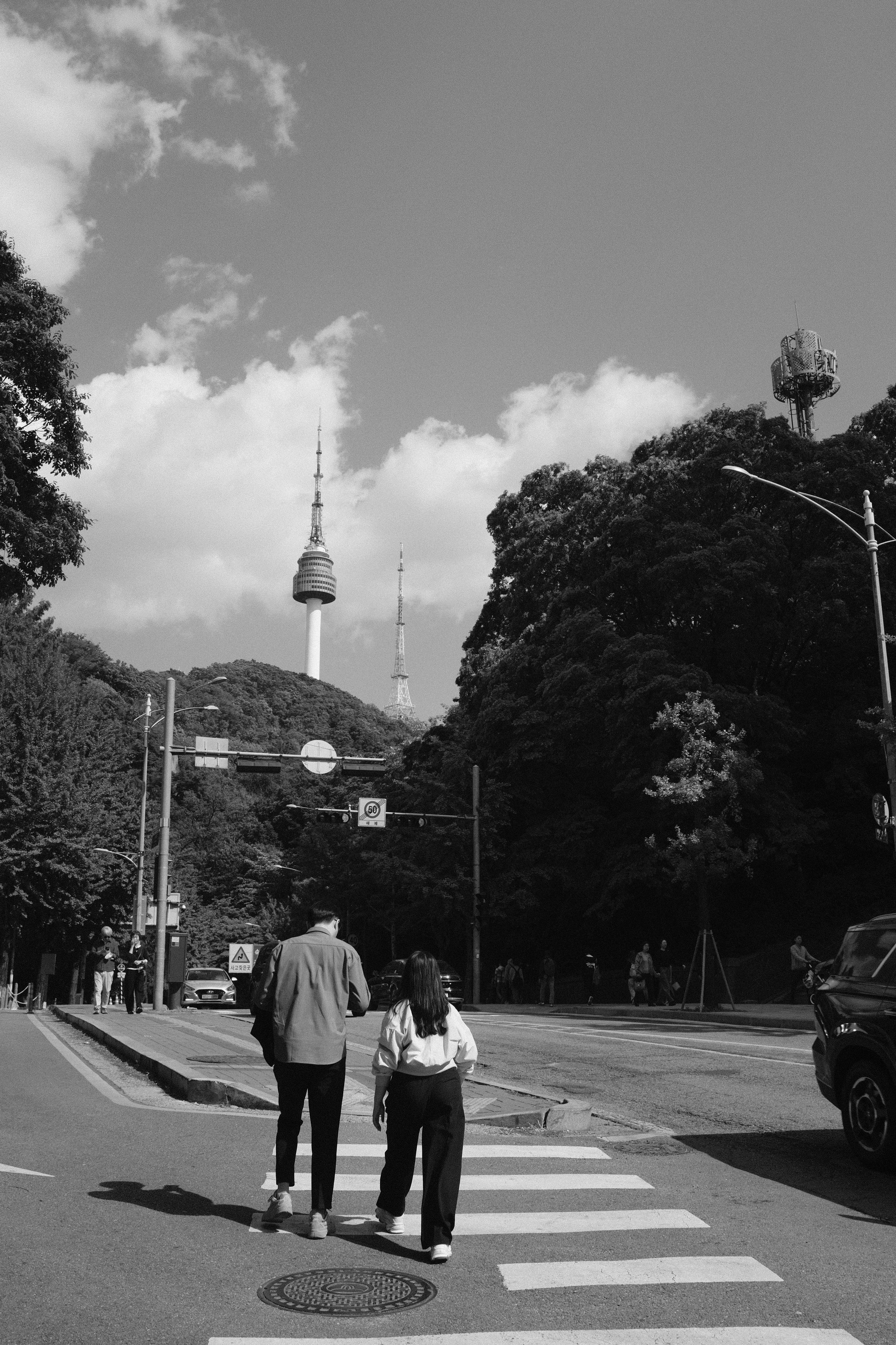 Silhouette Couple Crossing a City Crosswalk with Tower Skyline