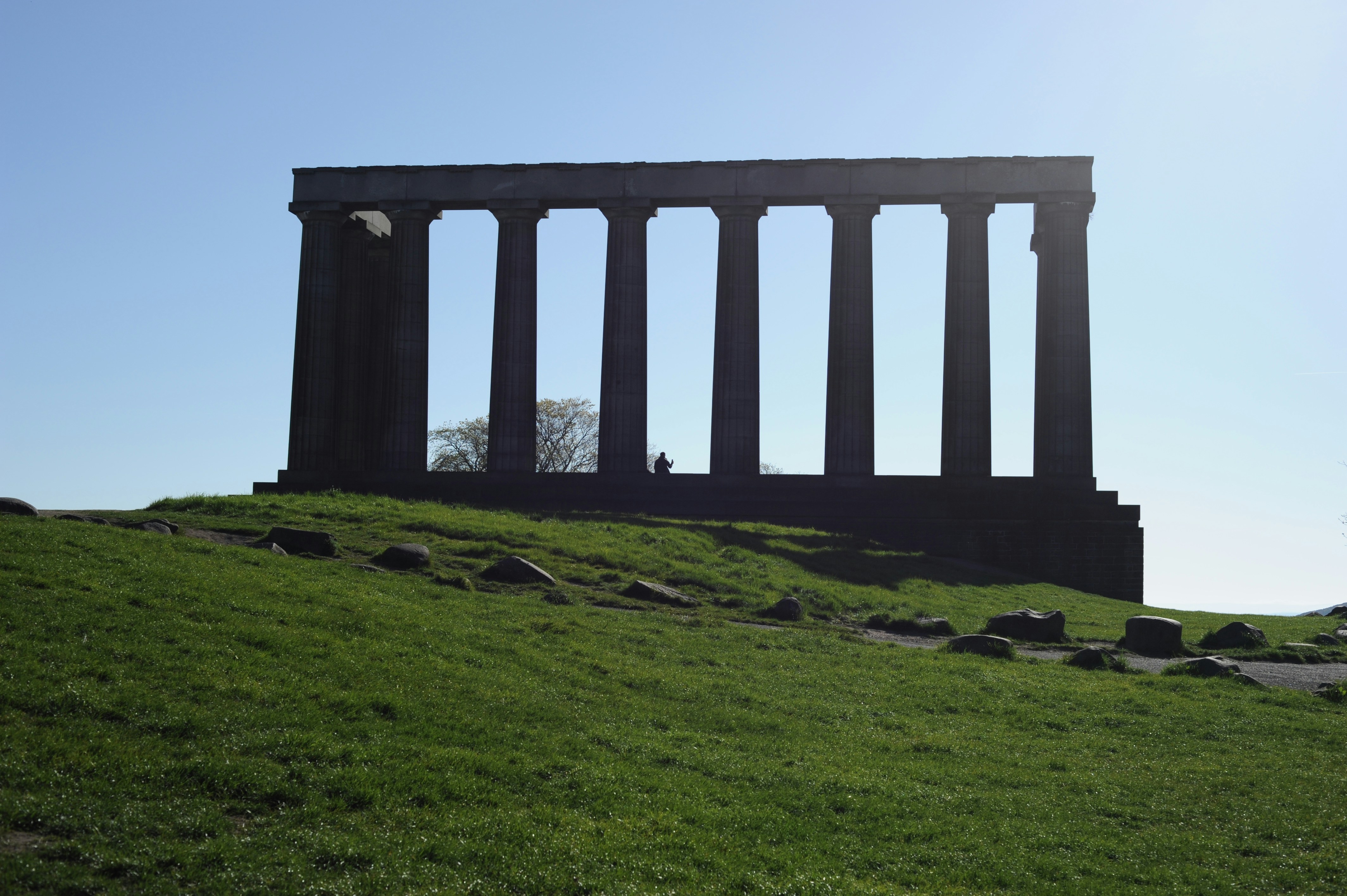 Silhouetted Ionic Gateway: A Hilltop Row of Columns Against a Clear Sky