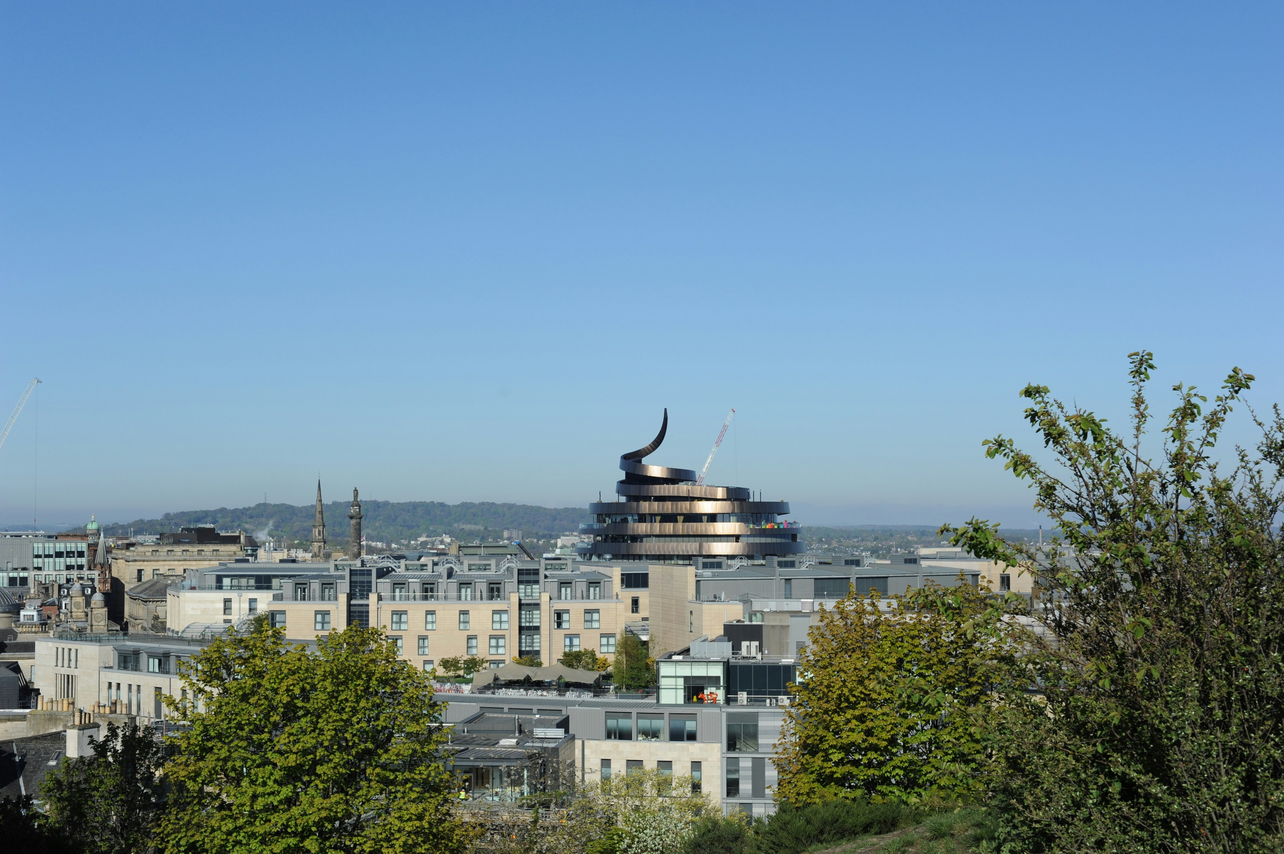 Cityscape Vista: The Curved High-Roof Landmark Rising Above the Rooftops