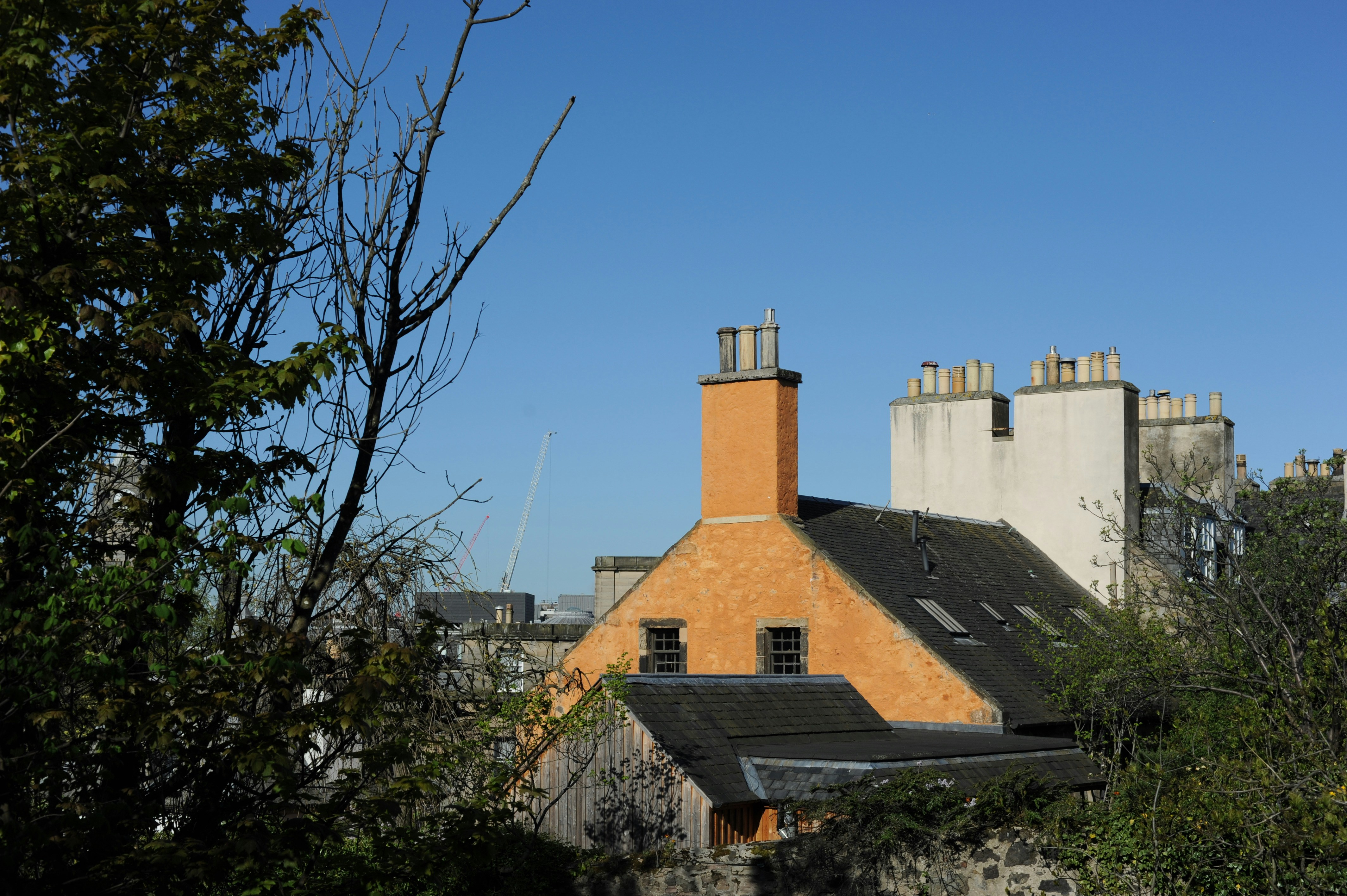 Sunlit Rooftop Chorus: Orange Brick Among Urban Peaks