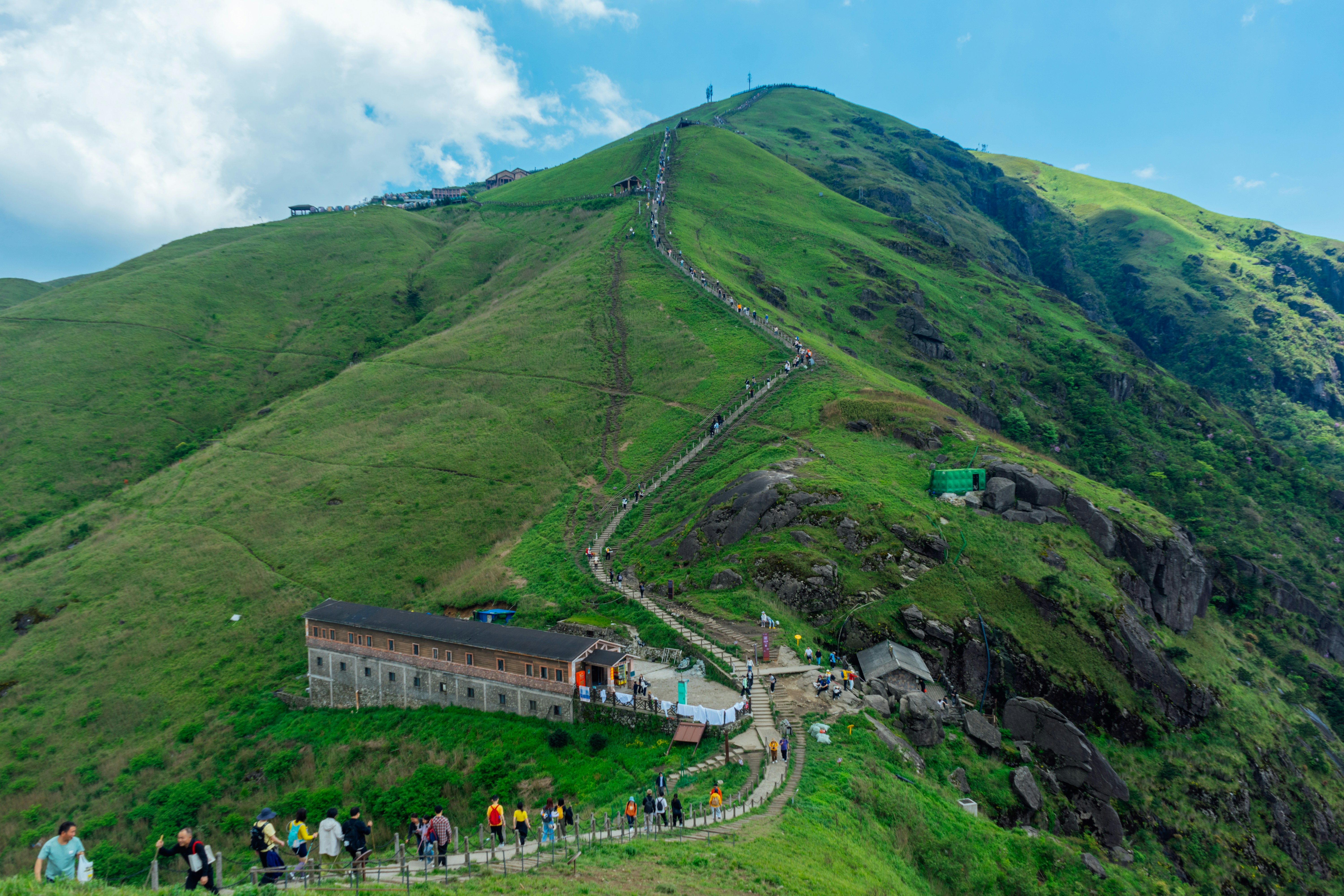 Trail to the Crest: A Green Summit Scene with a Historic Building