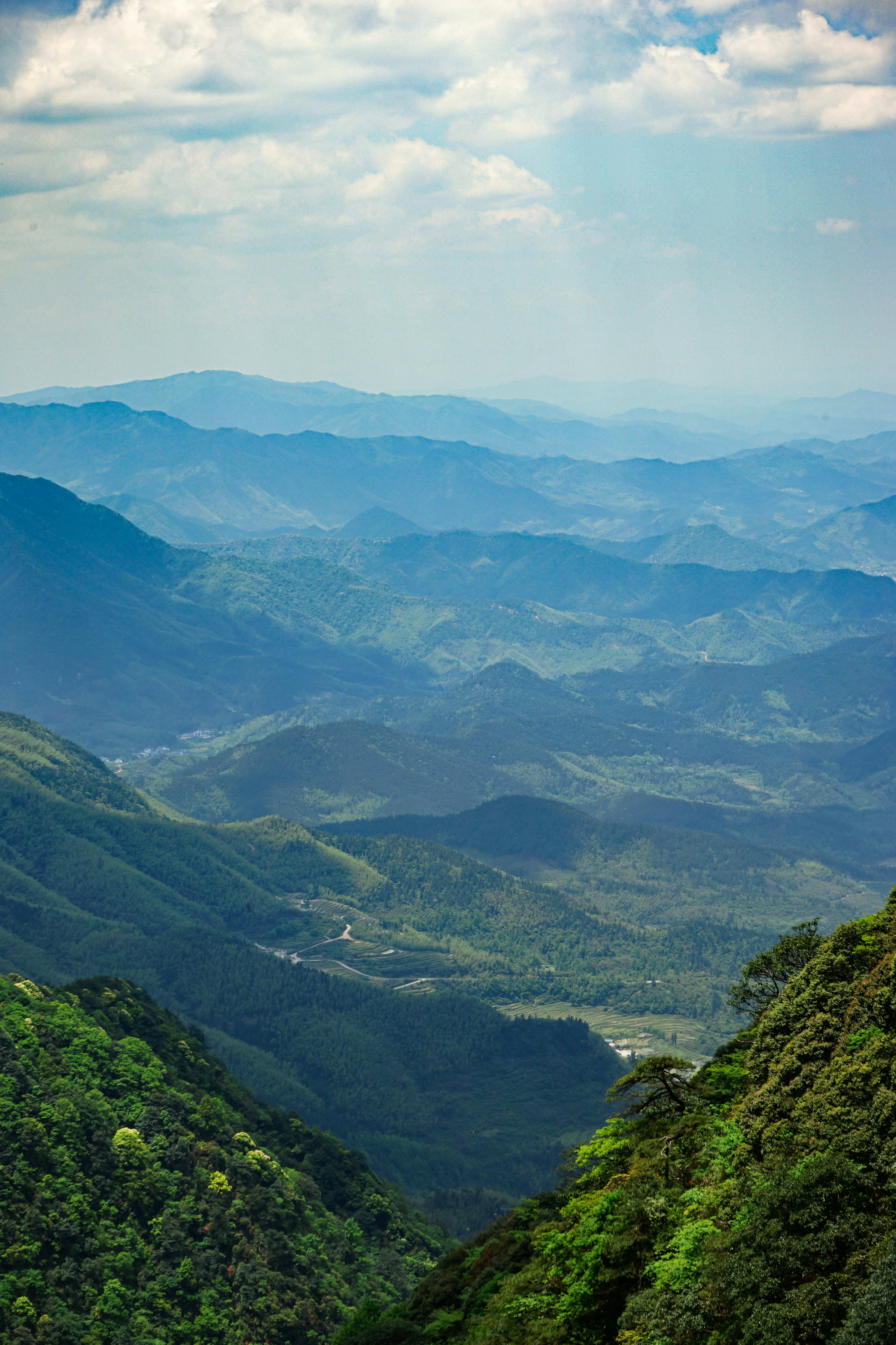 Valley Veil: A Layered Ridge Under Blue Haze