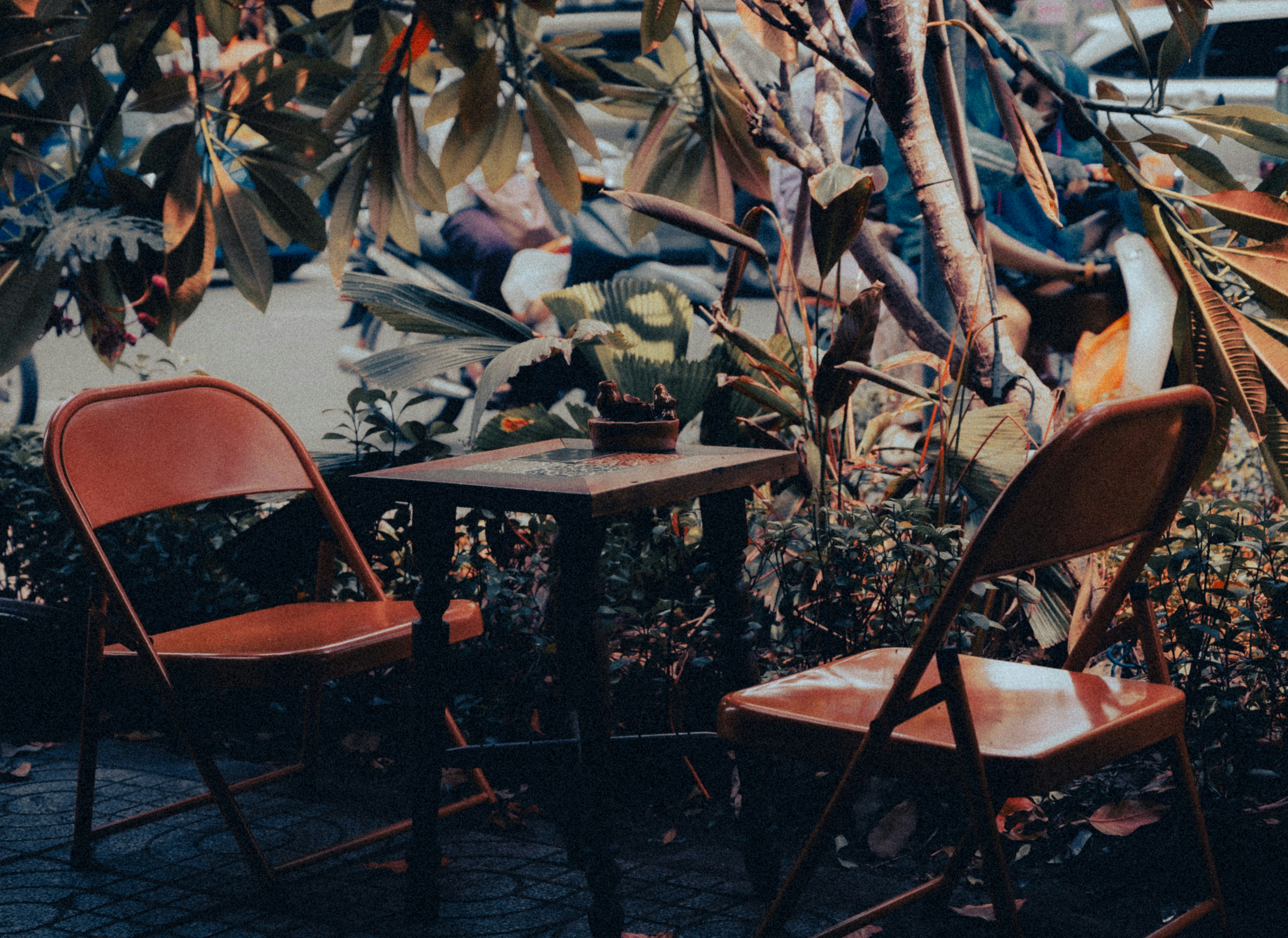 Quiet Corner Café: Faded Sunlight Between Orange Chairs