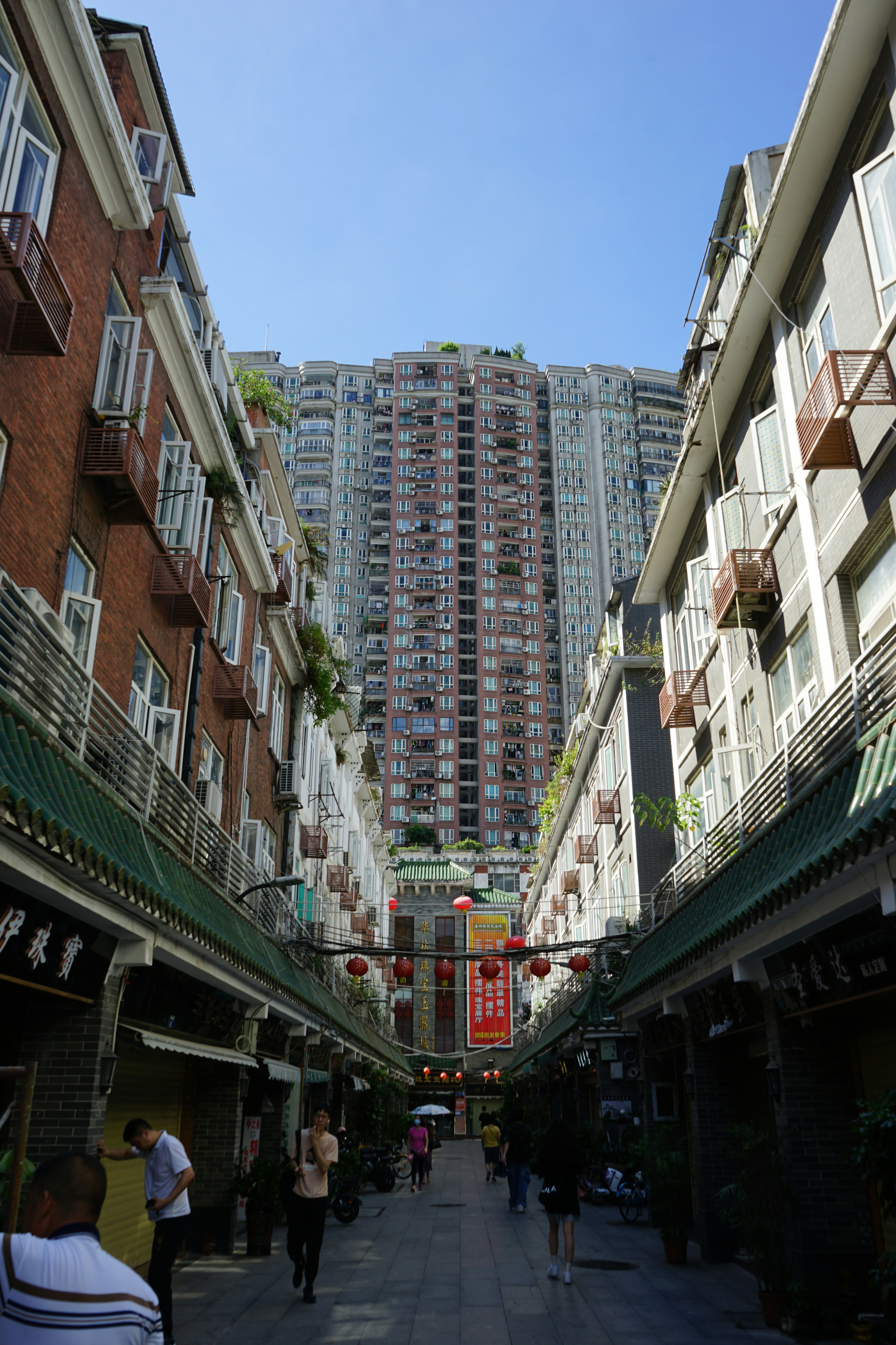 Skyrise over a Lantern-Lined Alleyway