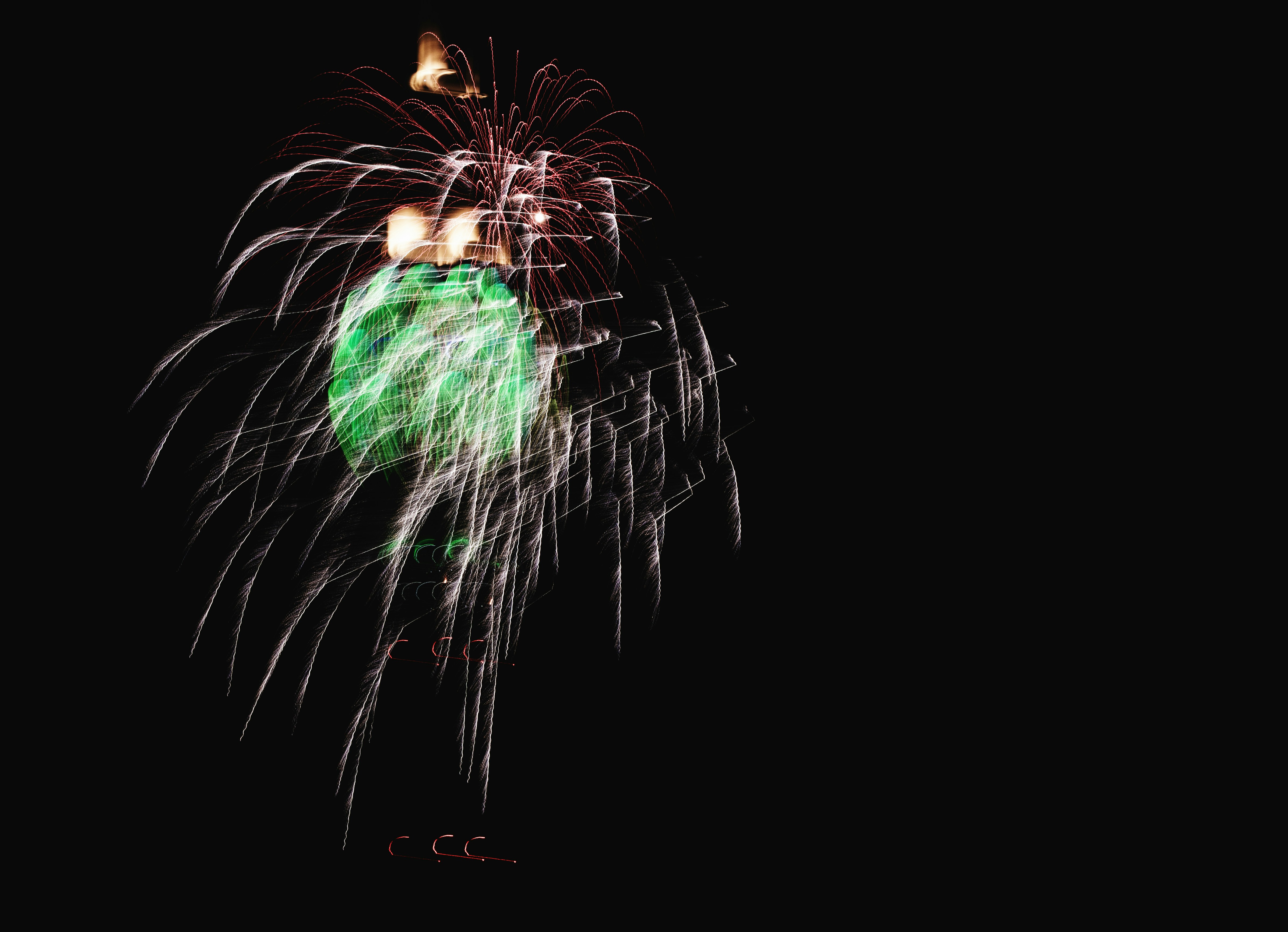 Green core under dark sky: a bursting firework portrait