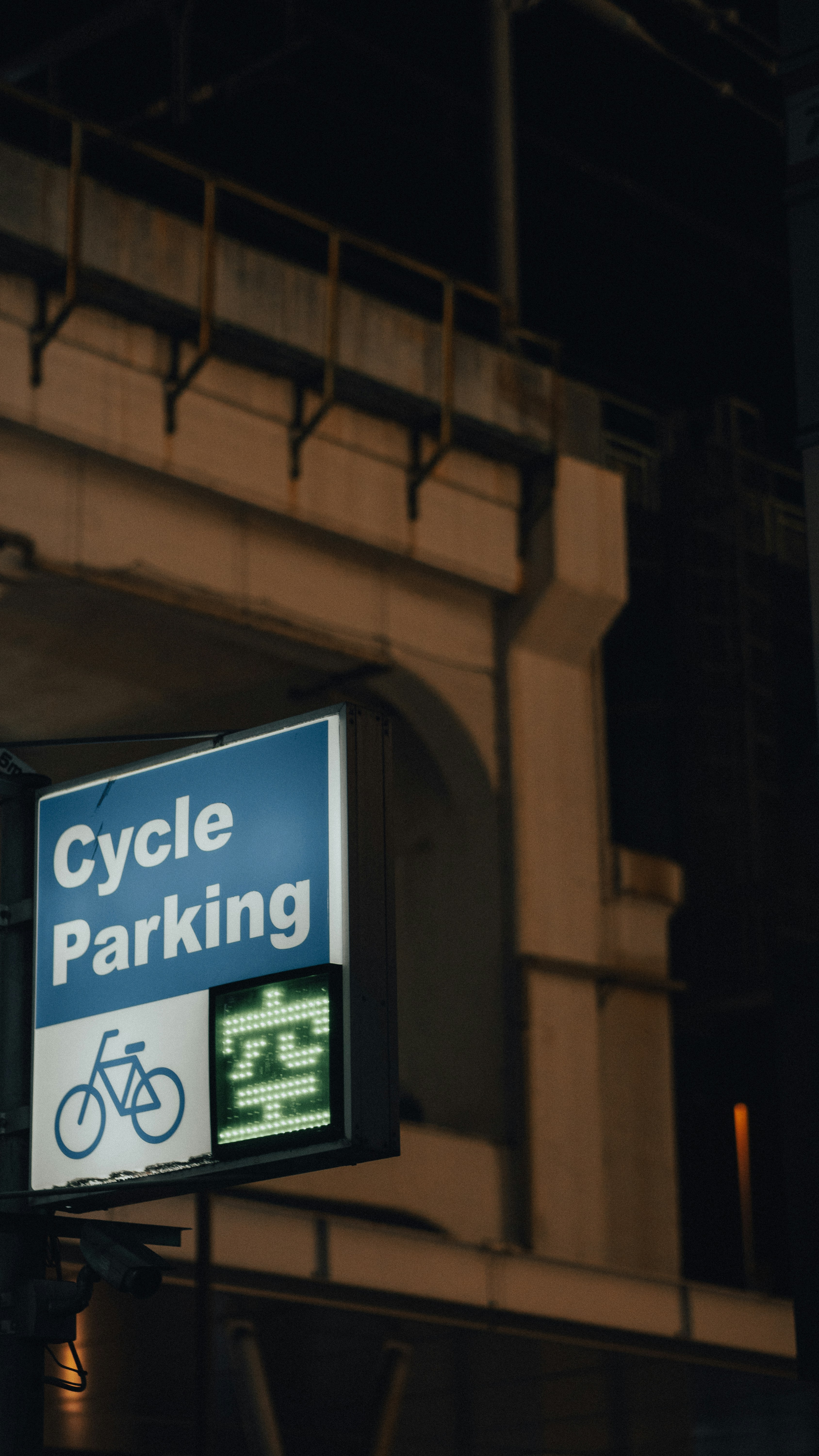 Night Under a Neon Sign: Cycle Parking Highlight