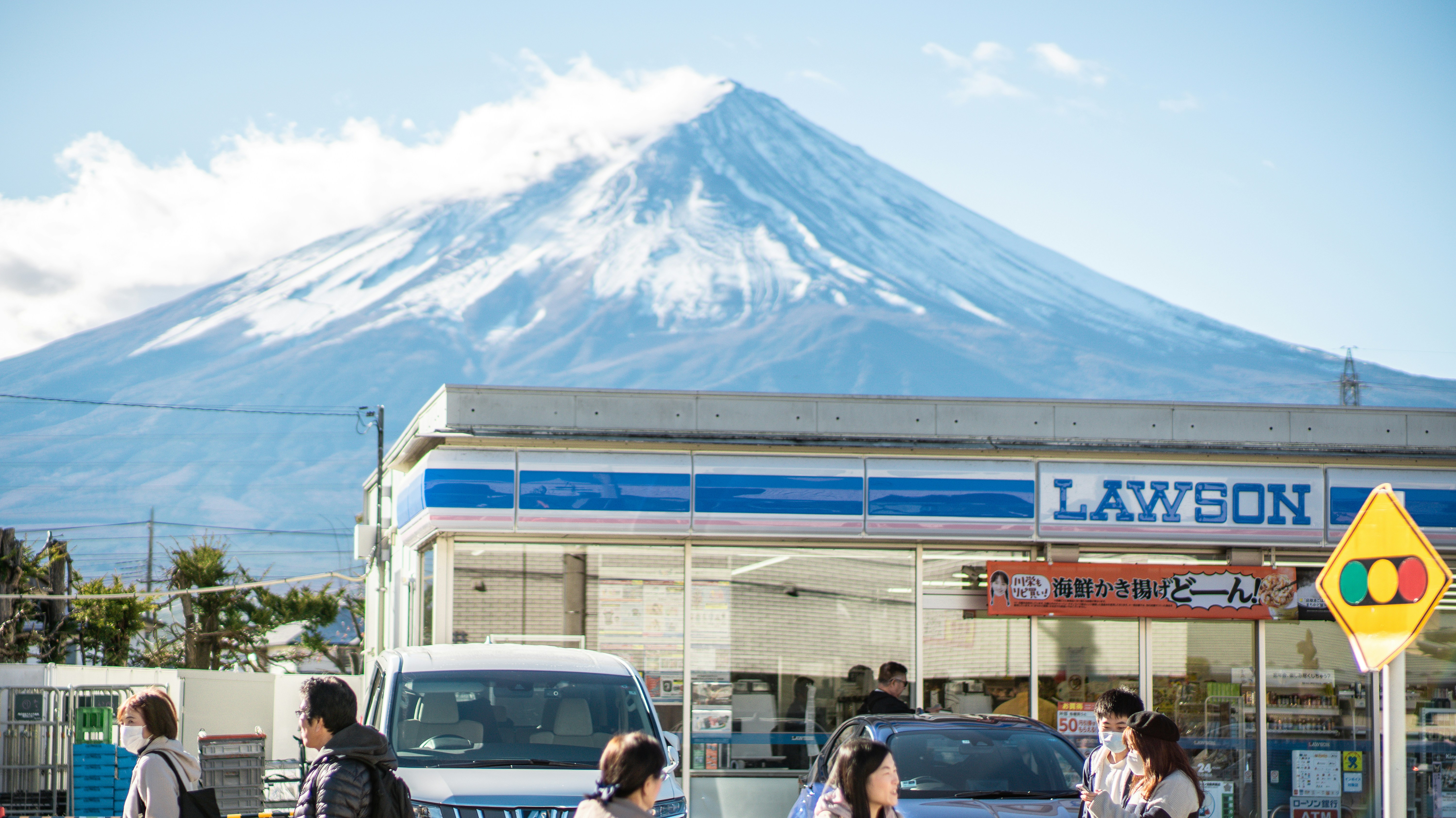 Blue-Cinned Convenience: Mount Fuji Watching Over a Busy Street