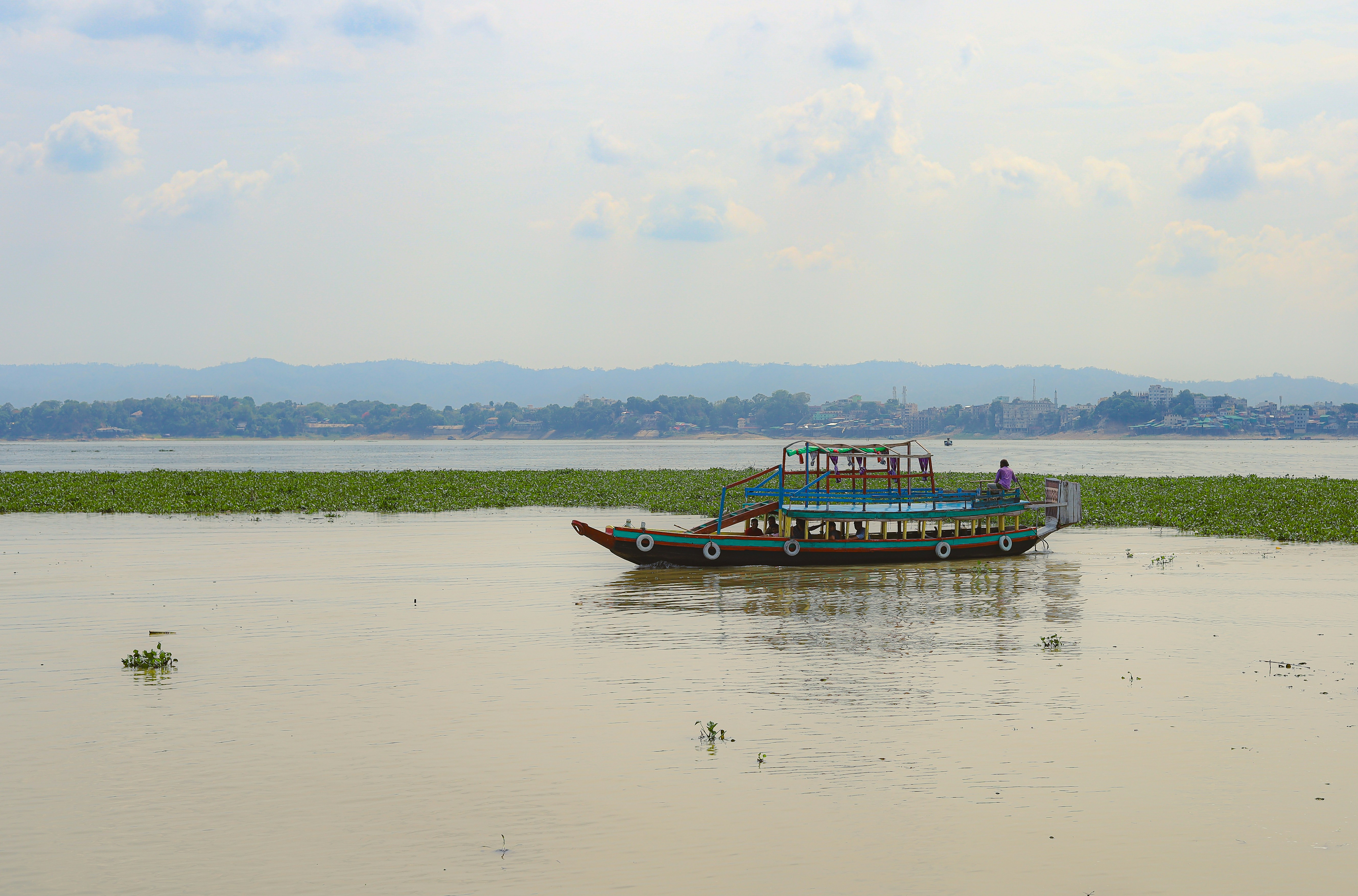 Midday Sail: A Painted Boat Drifting on Quiet Waters