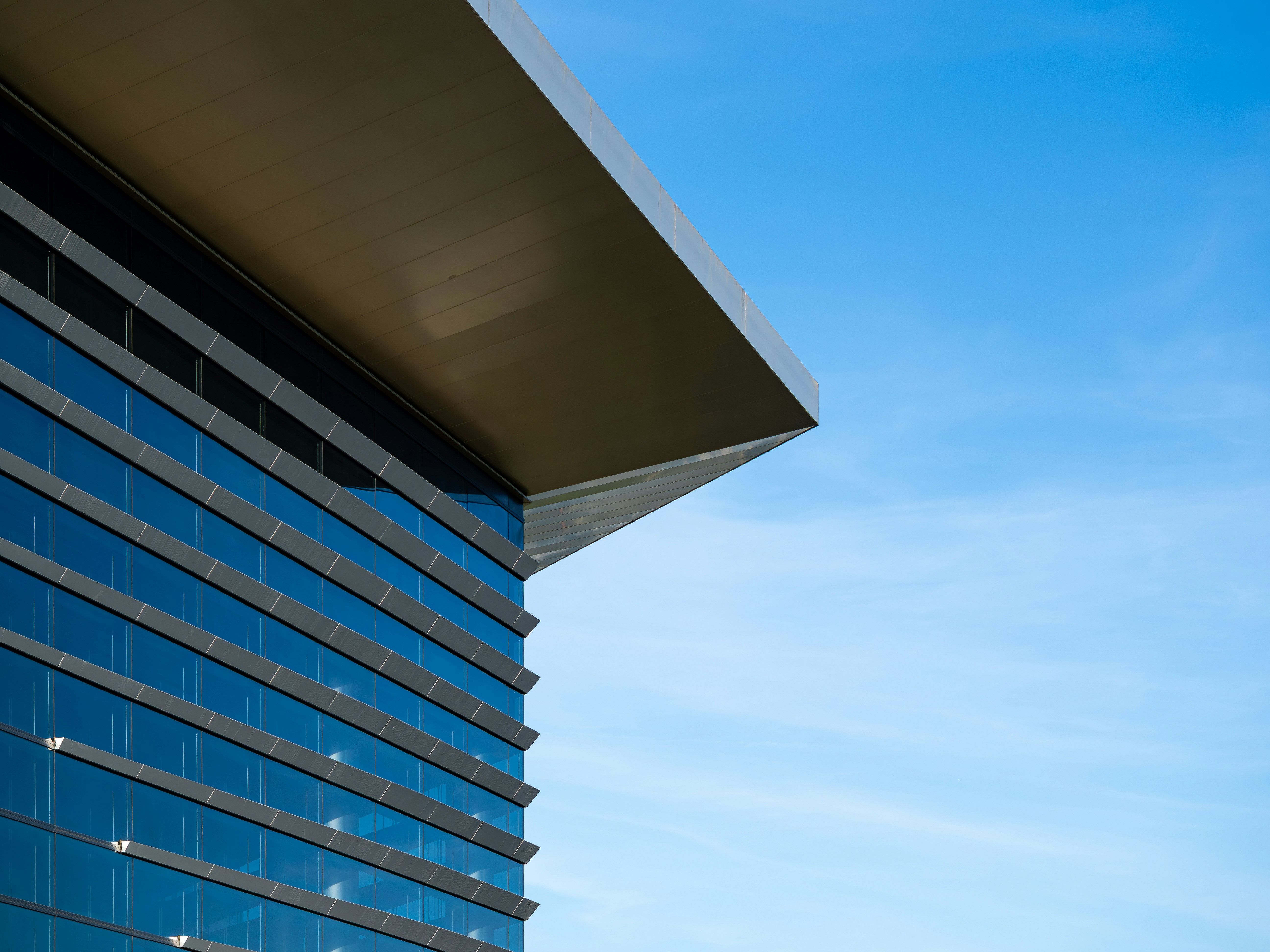 Blue Glass Facade under a Sharp Overhang