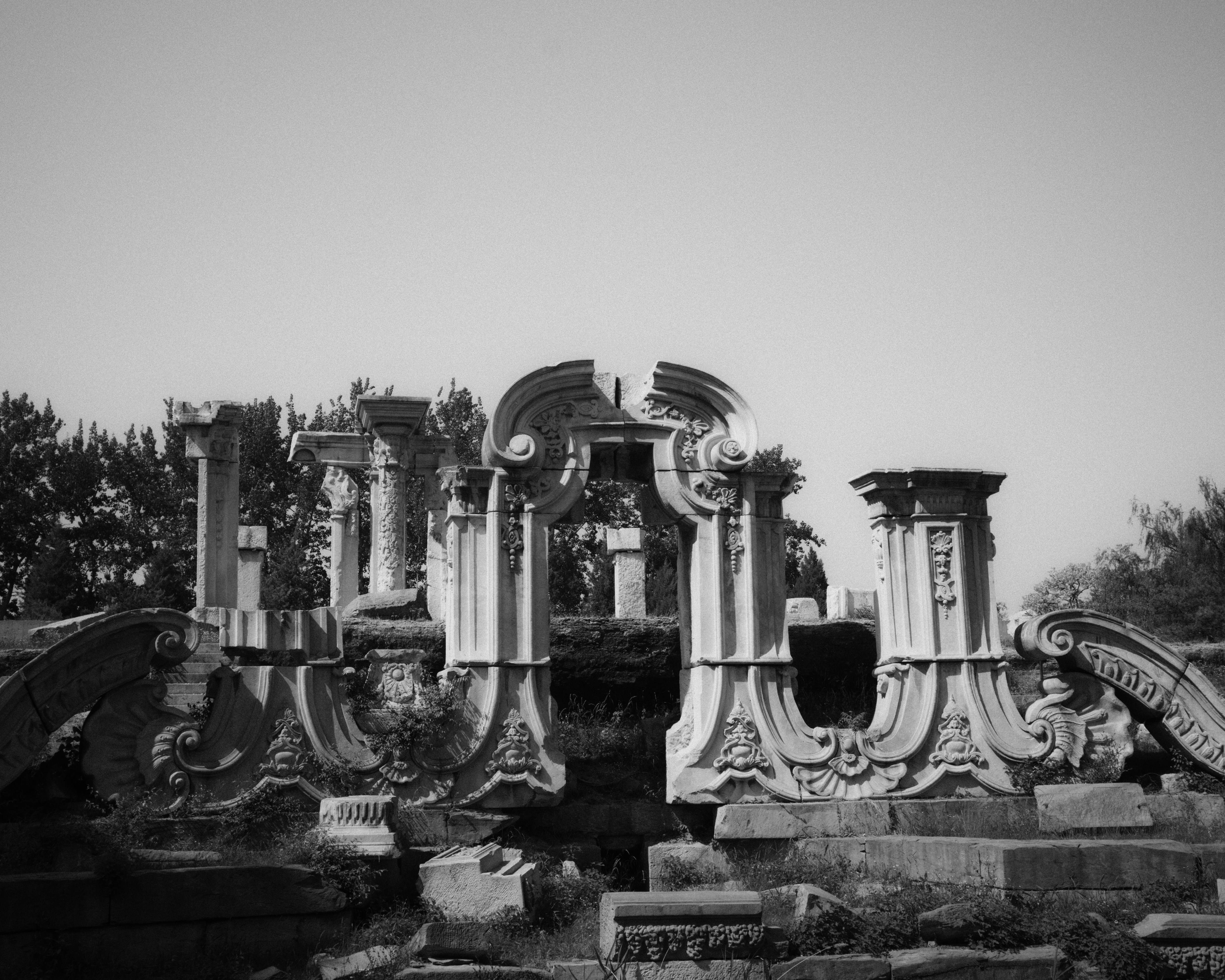 Ruined Archway Framed by Weatherted Columns in a Deserted Courtyard