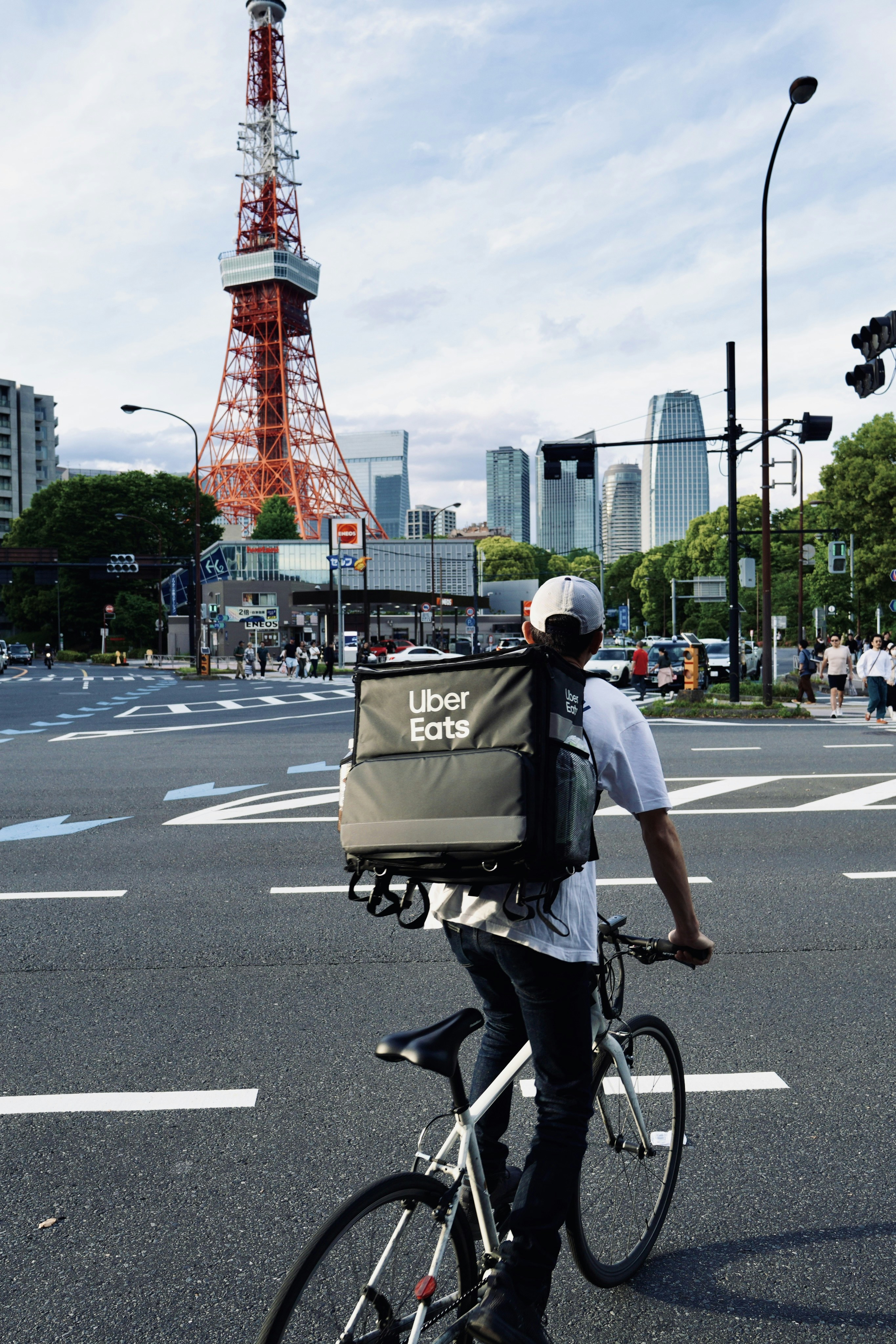 Courier on the Tokyo-like Crossroads beneath a Towering Skyline