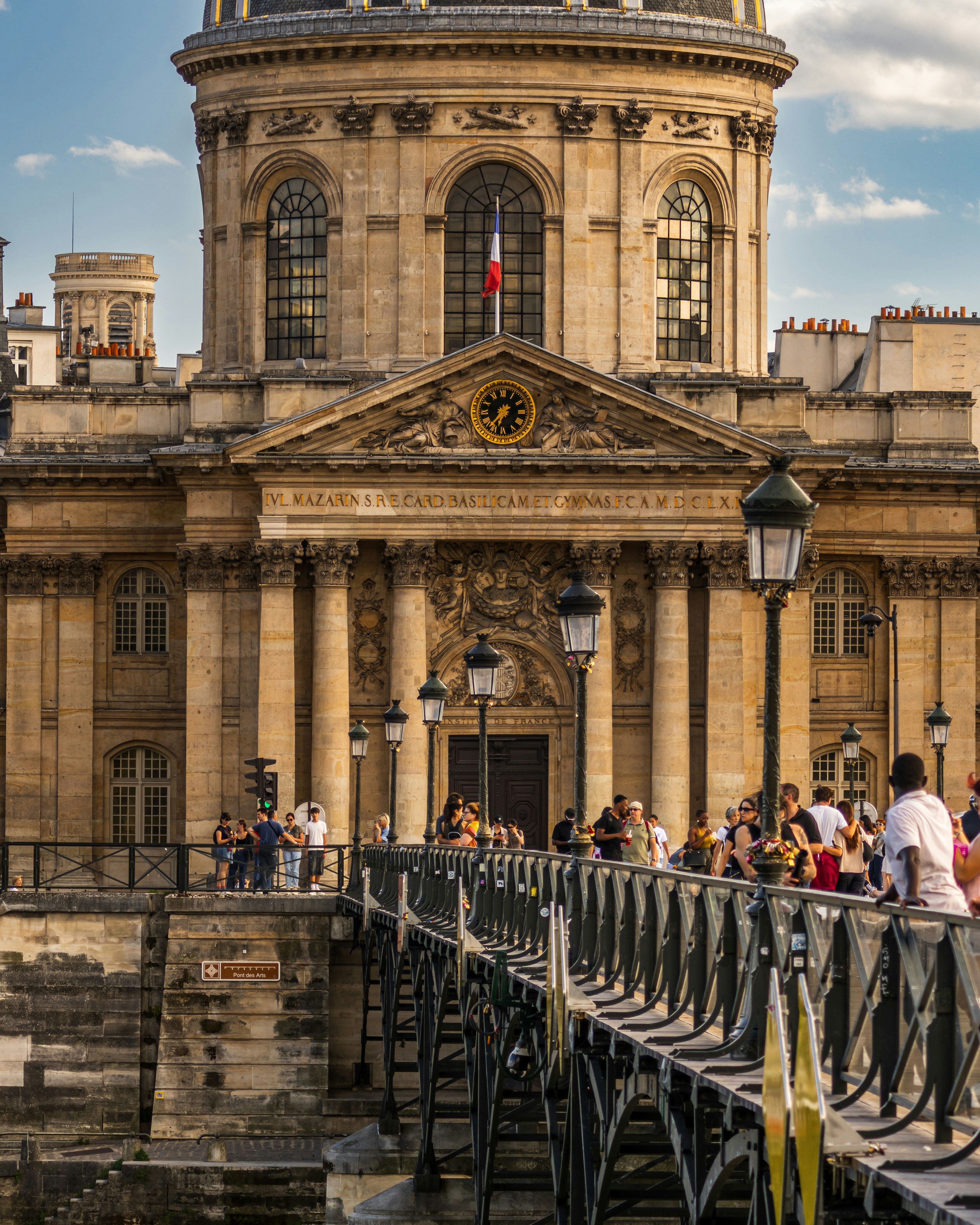 Bridge to the Grand Facade: Tourists Amid Historic Lights