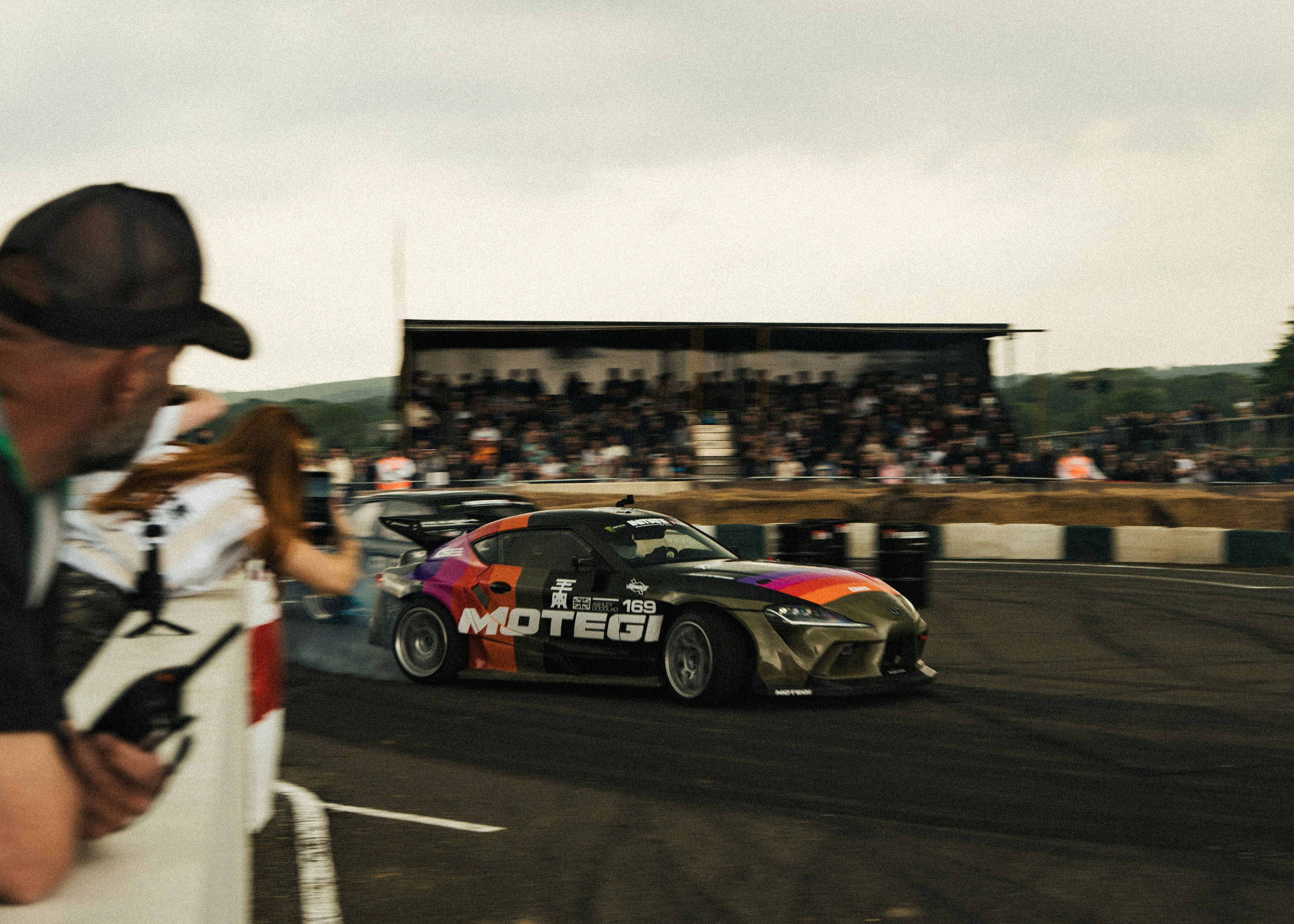 Race Car in Motion: Blurred Crowd and On-Track Drama