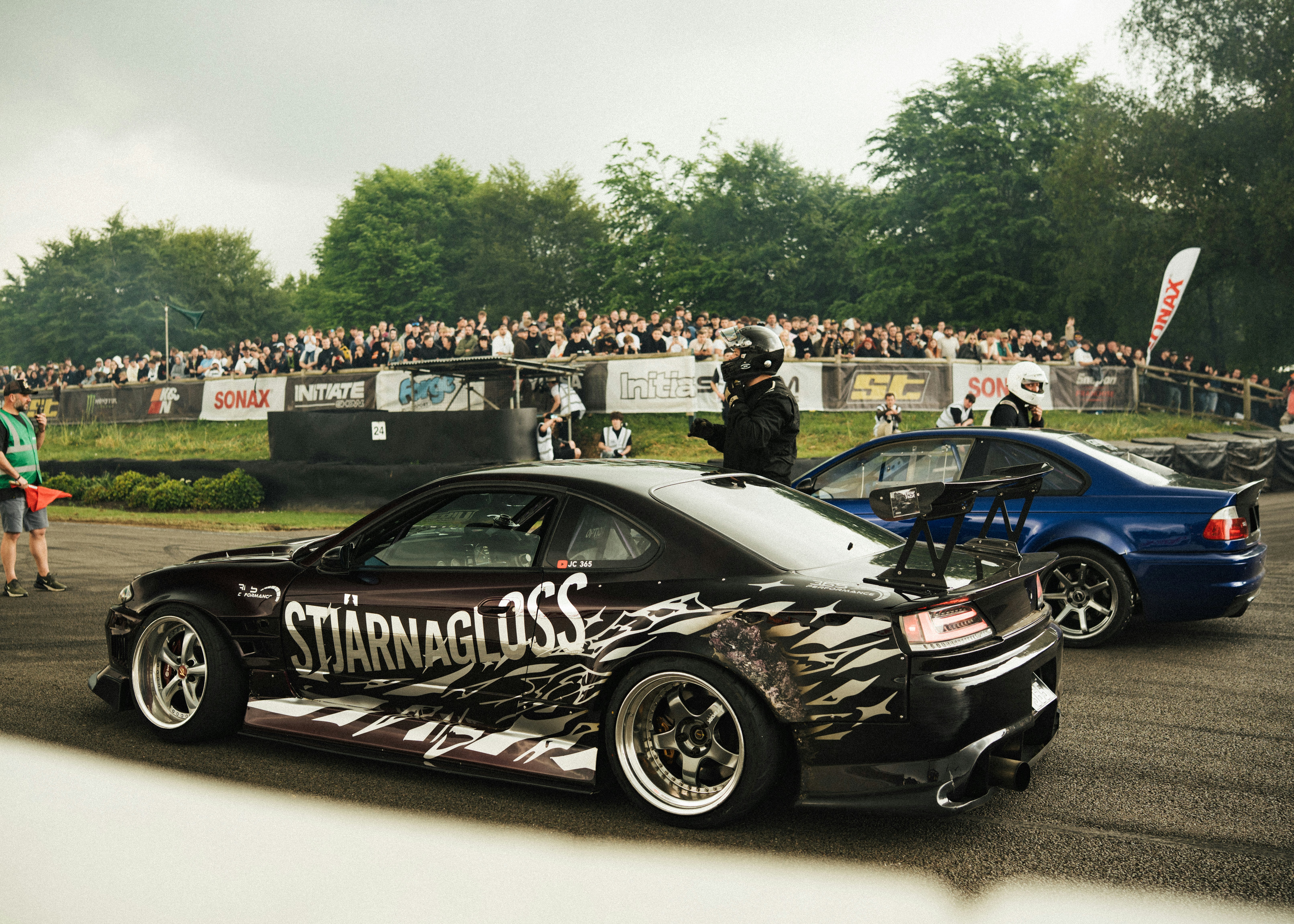 Stickered Drifter: A Dark Racing Dream Surfaces at the Track