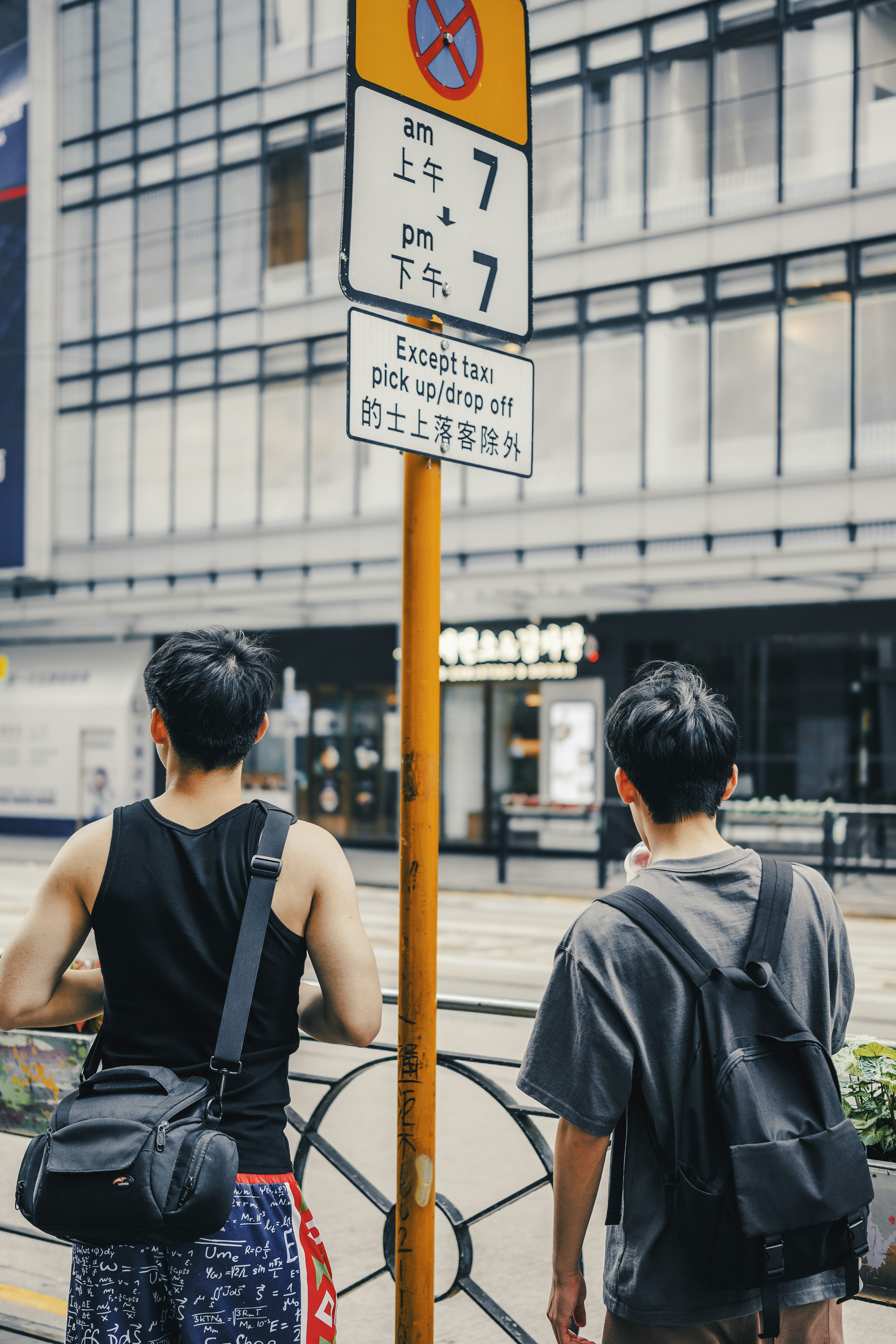Urban Street Duo Beside a Signpost