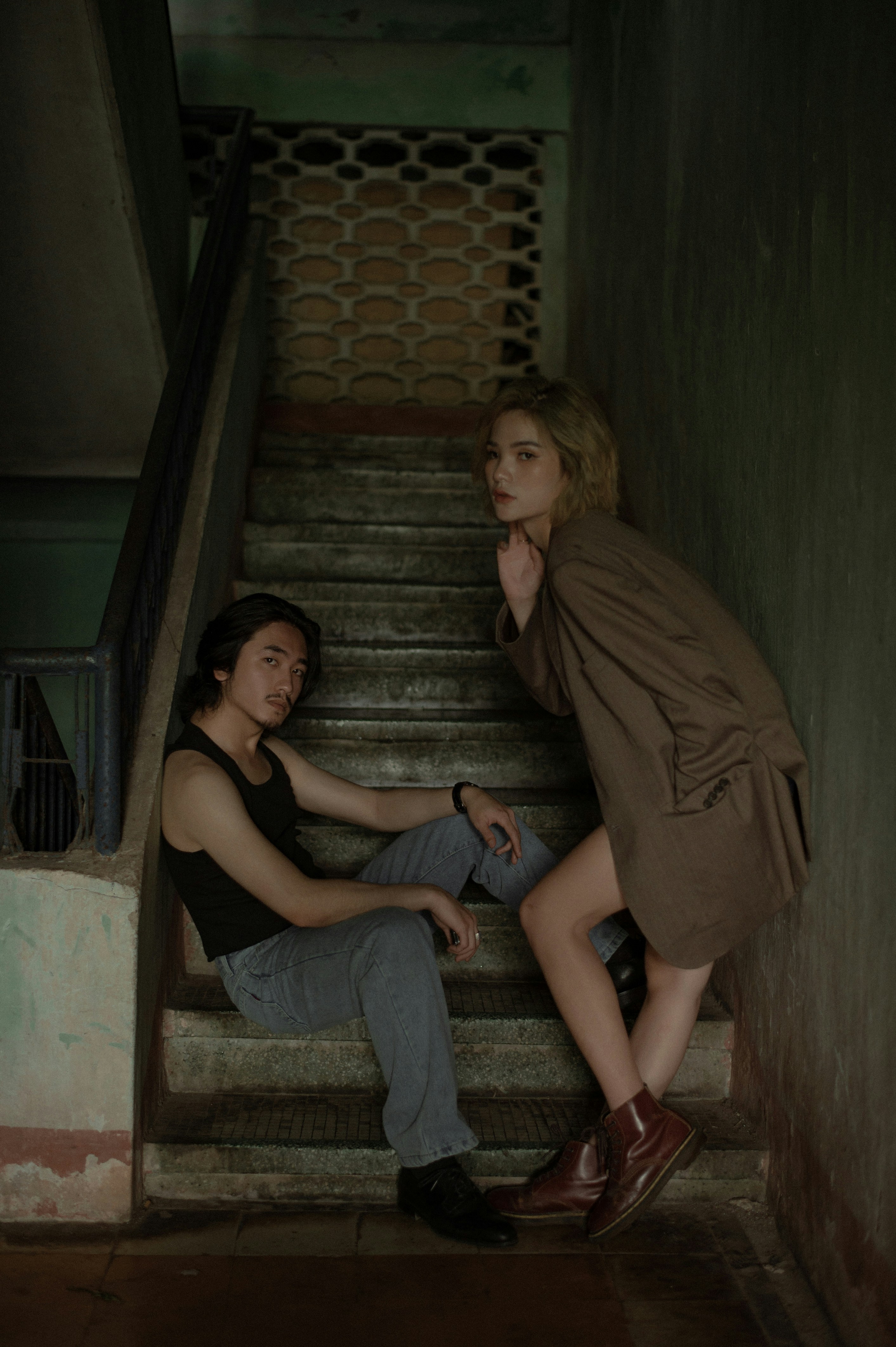 Stairwell Conspiracy: Two Figures Paused in Neon-Dim Quiet