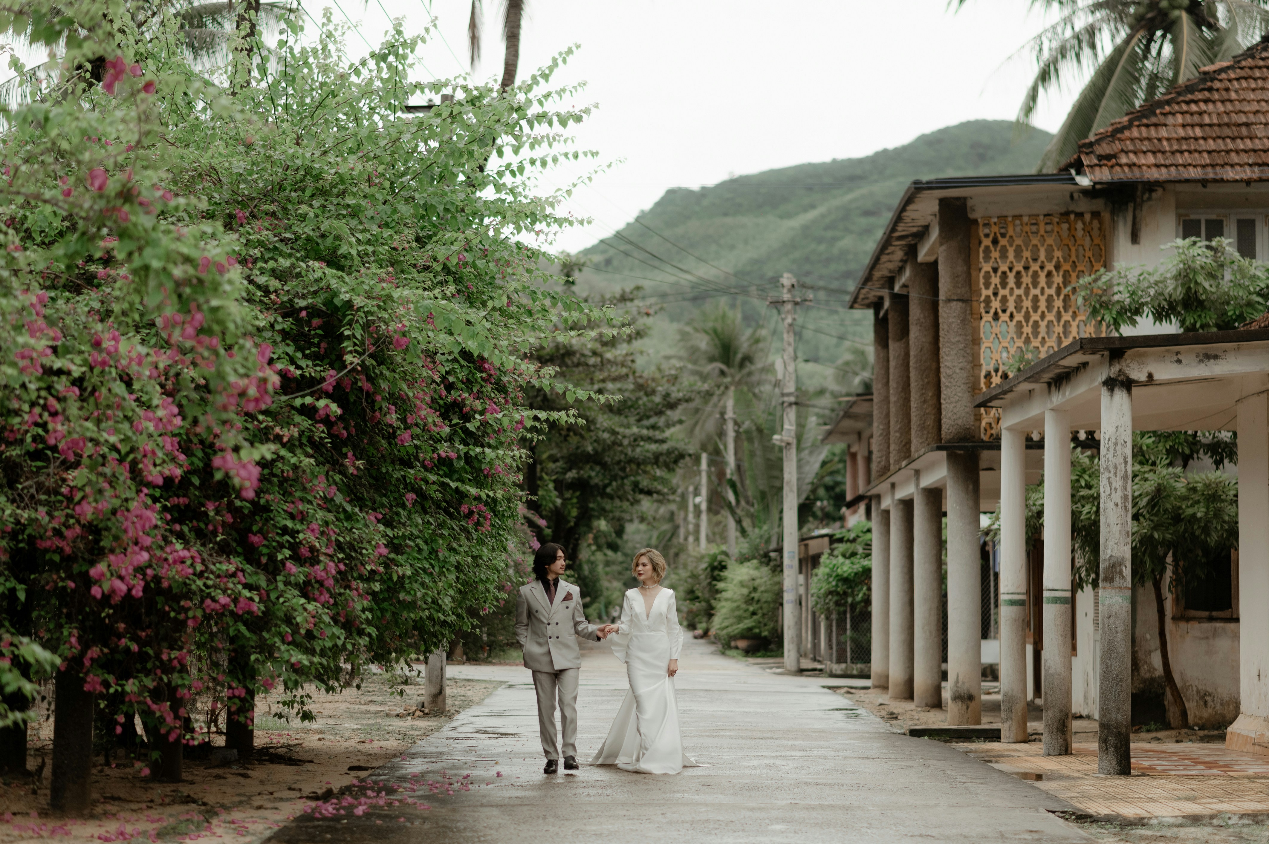A Quiet Walk: Bride and Groom Stroll Down a Village Lane