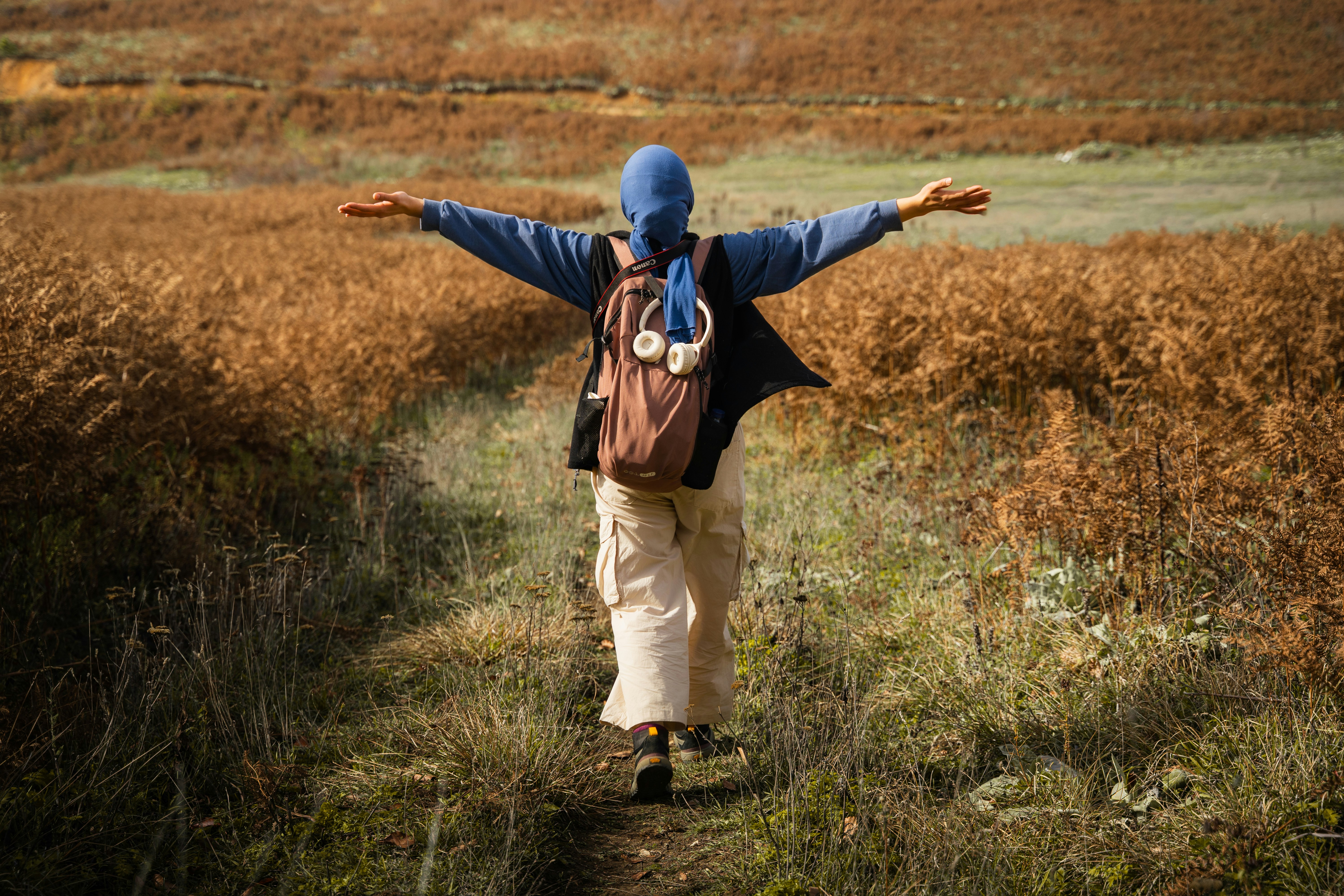Outstretched Freedom: A Traveler Embraces the Open Field