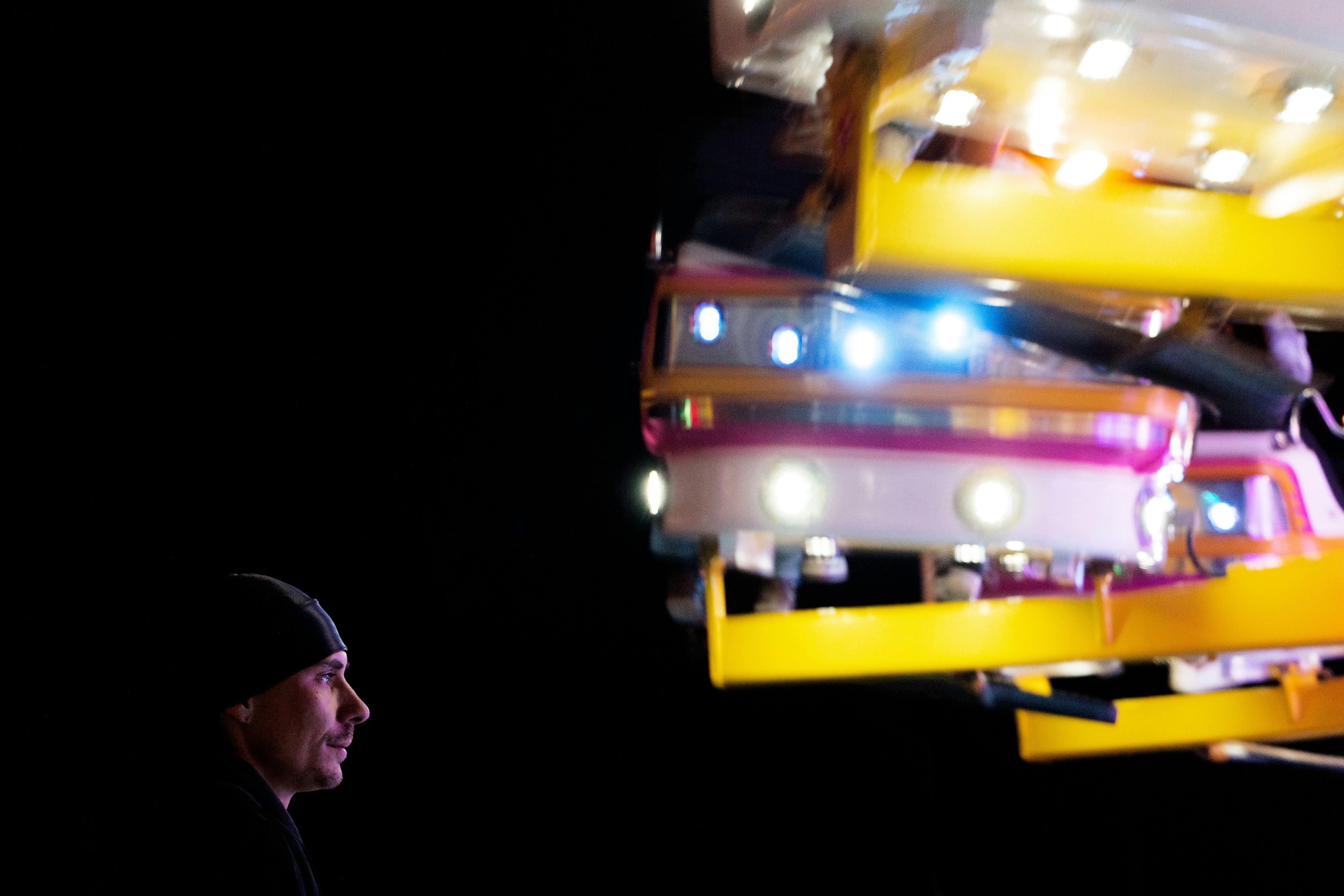 Night Scene: A Lone Observer and a Blurred Carnival Carriage Streak