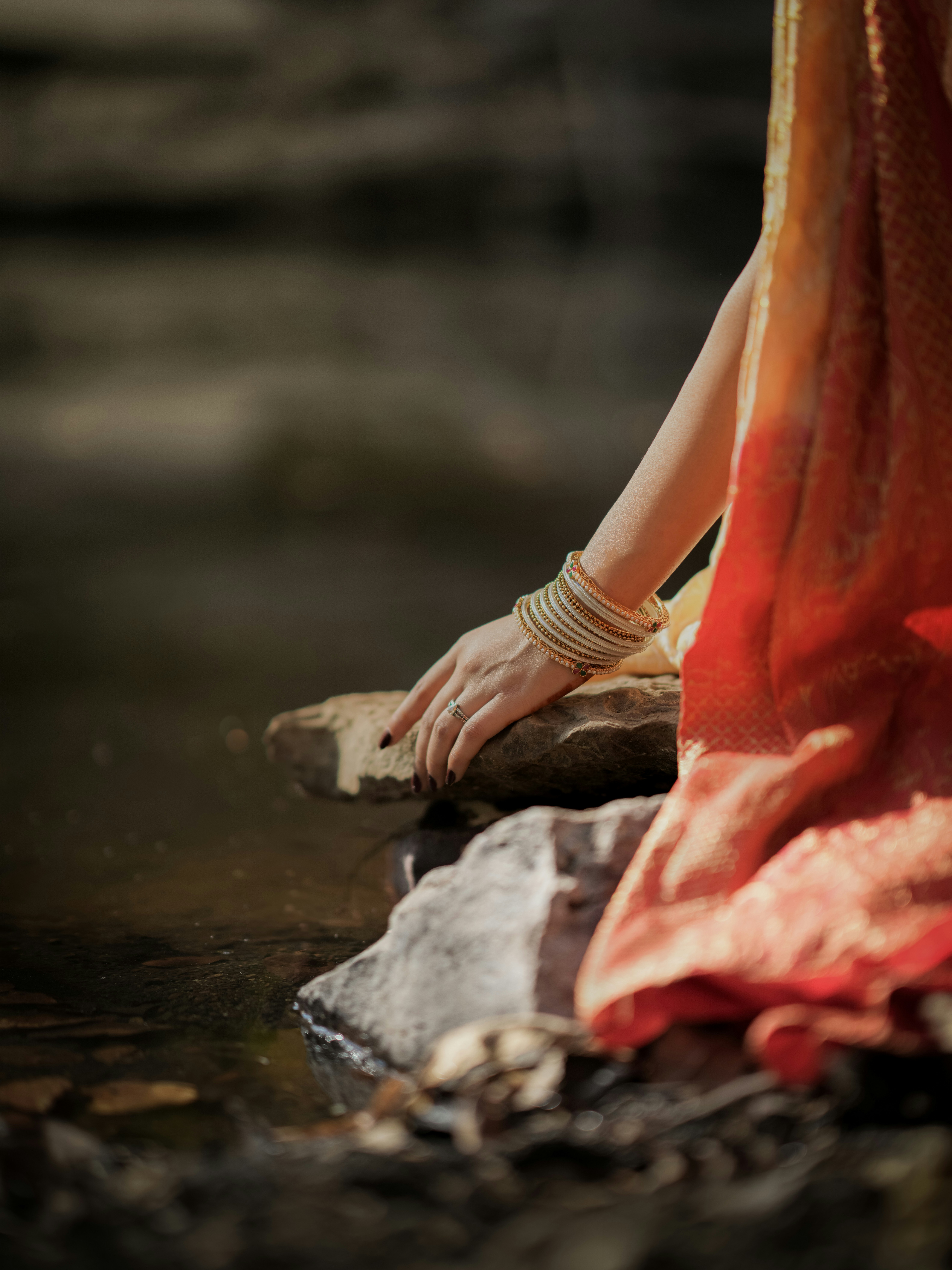Amber Draped Silhouette: A Hand Resting by the Water