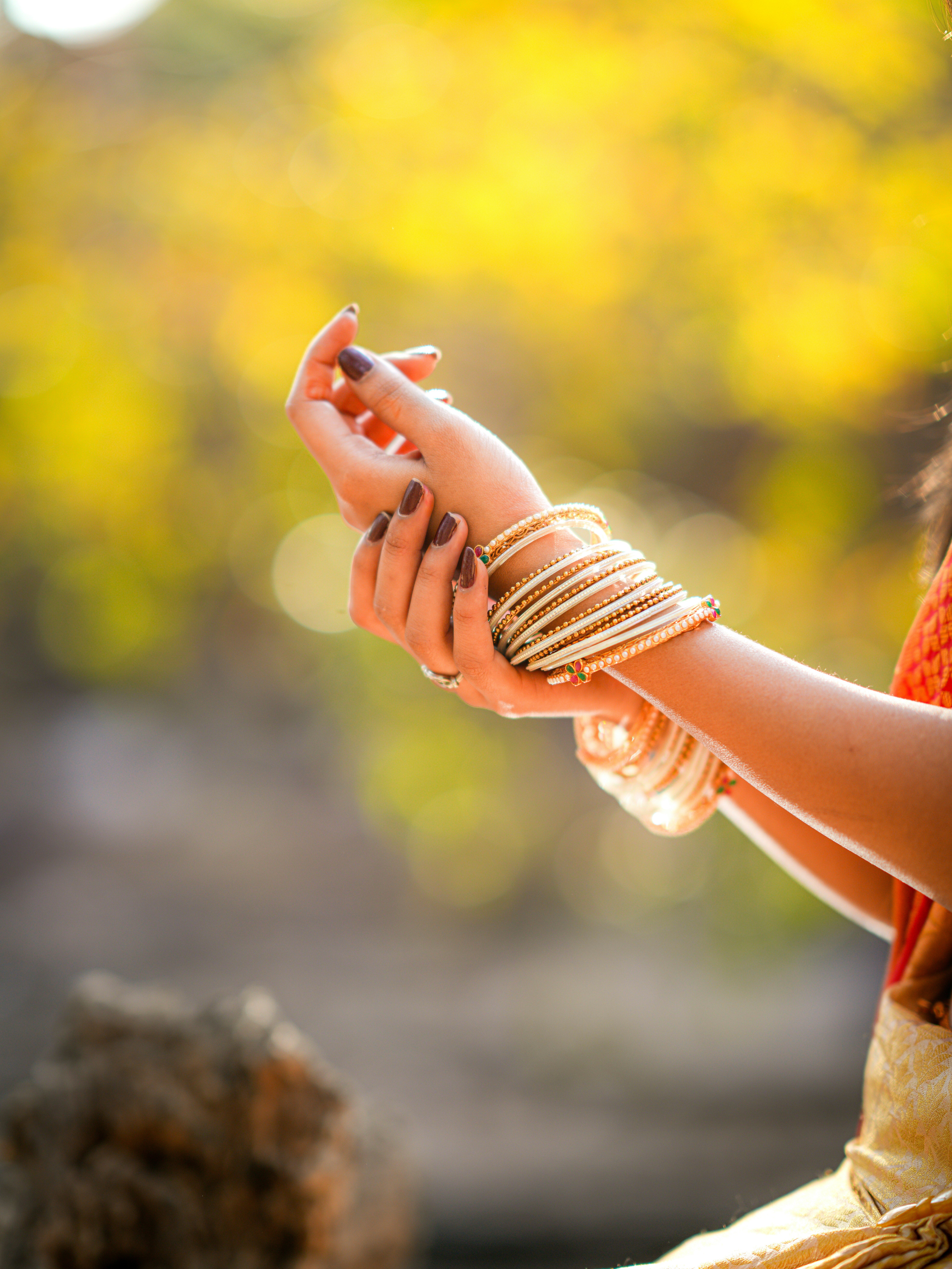 Grace in Gold: A Handful of Bangles in Sunlit Bokeh