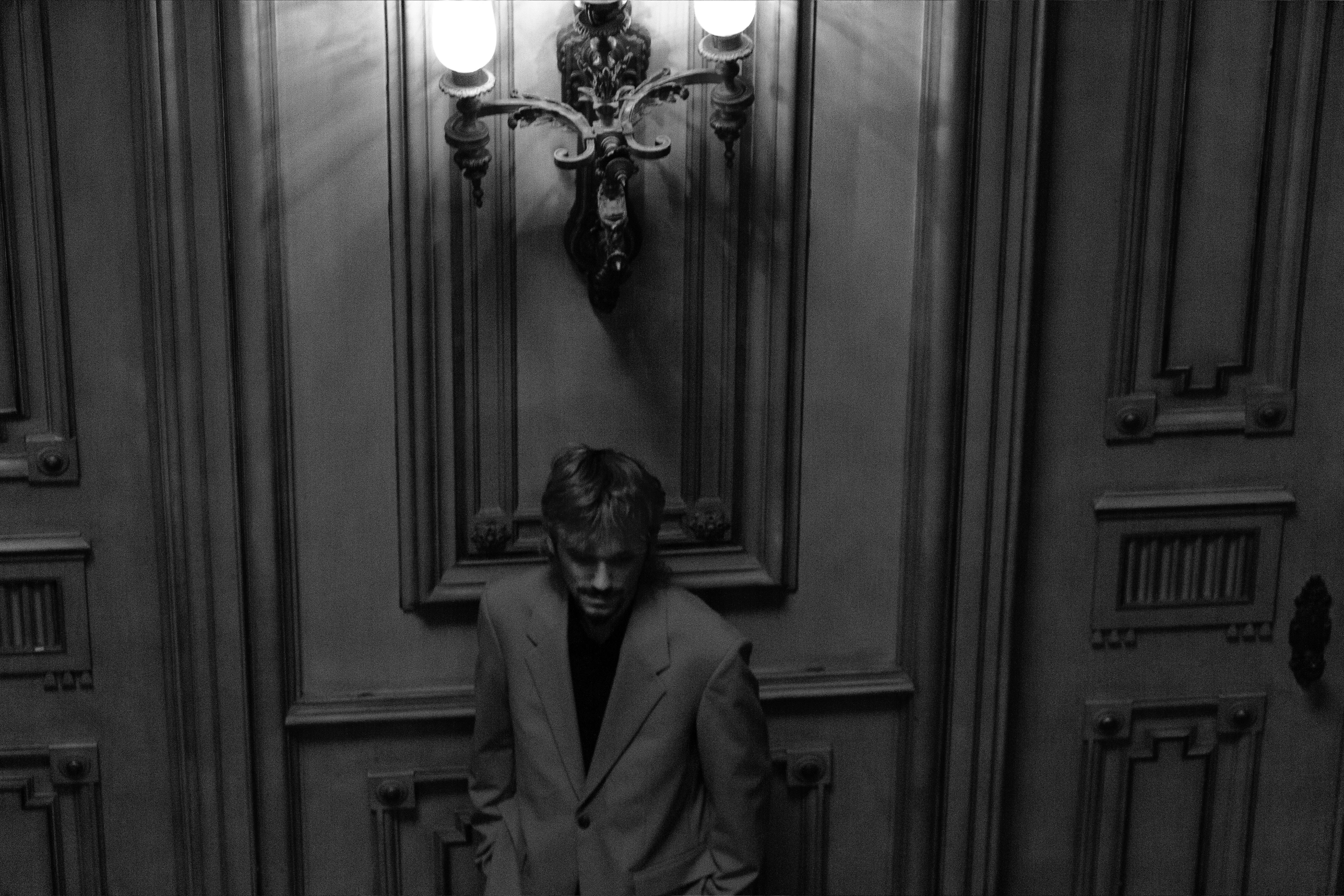 Man in a Dimmed Hallway: A Quiet Portrait in Shadows