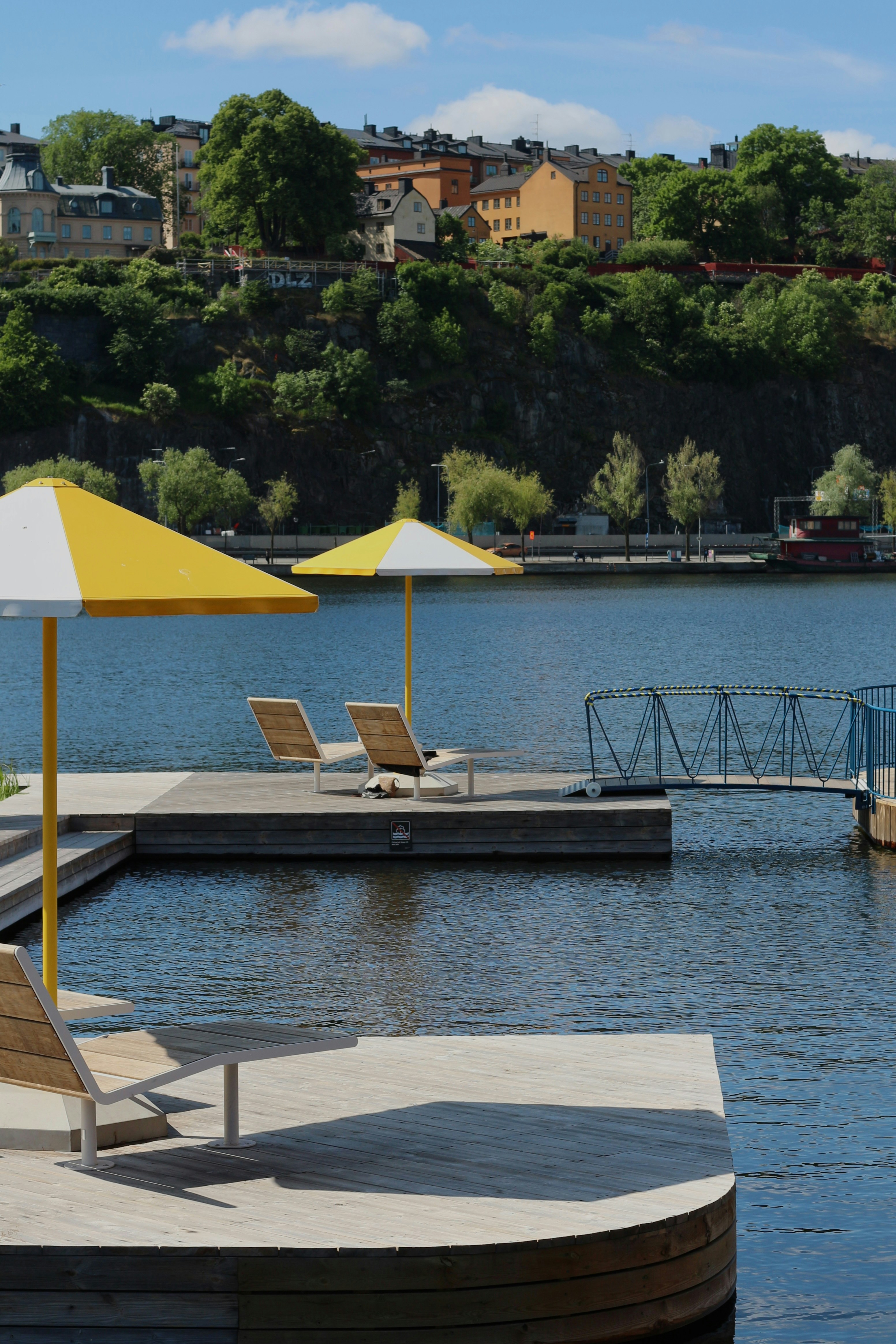 Sunlit Waterfront Decks Meet Distant Hillside Village