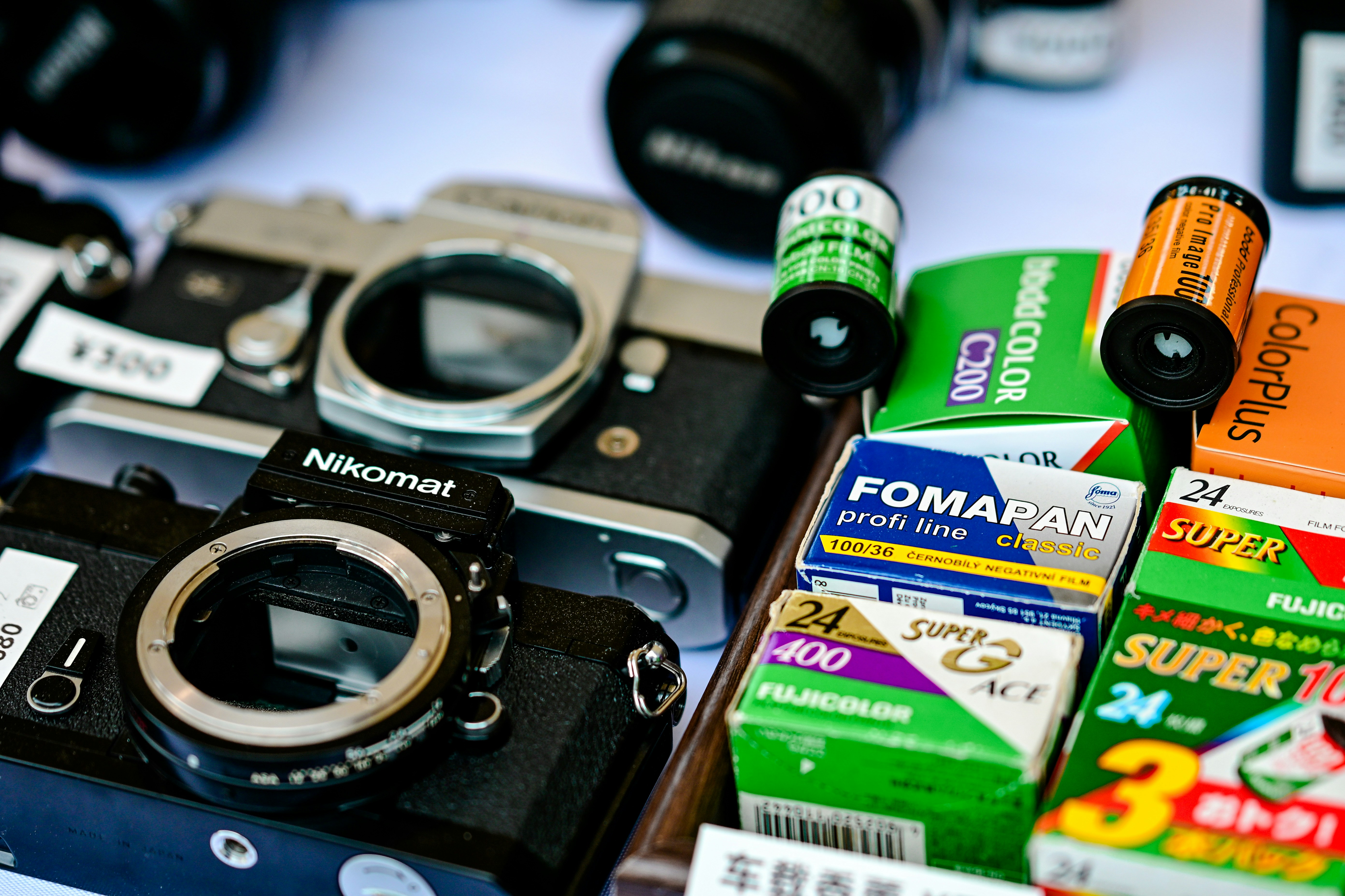Nostalgia in Focus: A Vintage Lot of Lenses and Colorful Film Packs