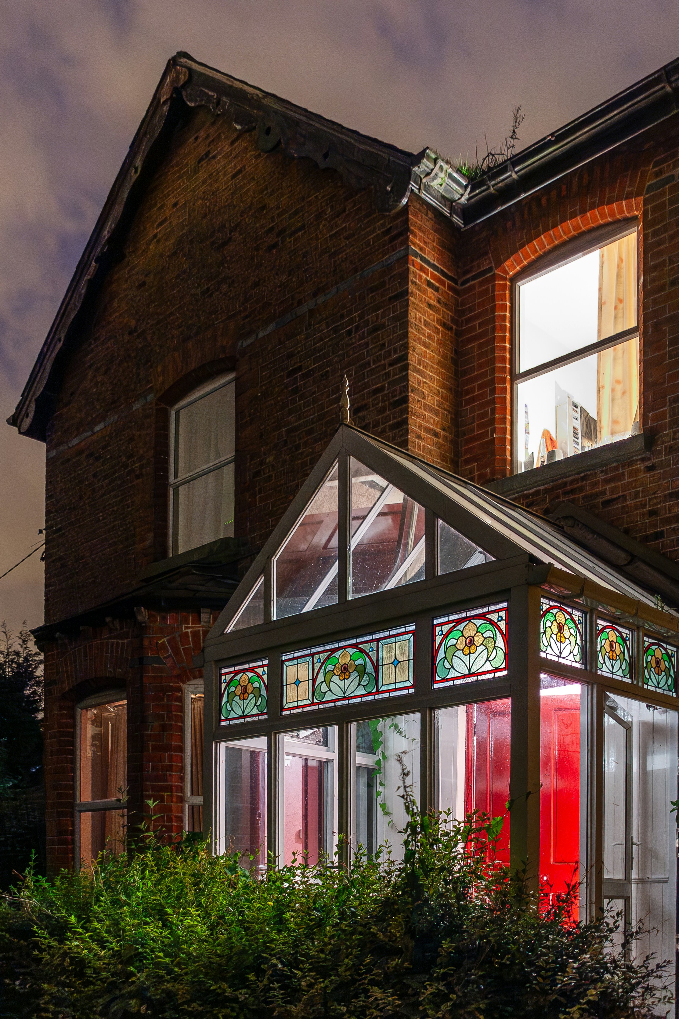 Glowing Conservatory Adjoins a Vintage Brick House
