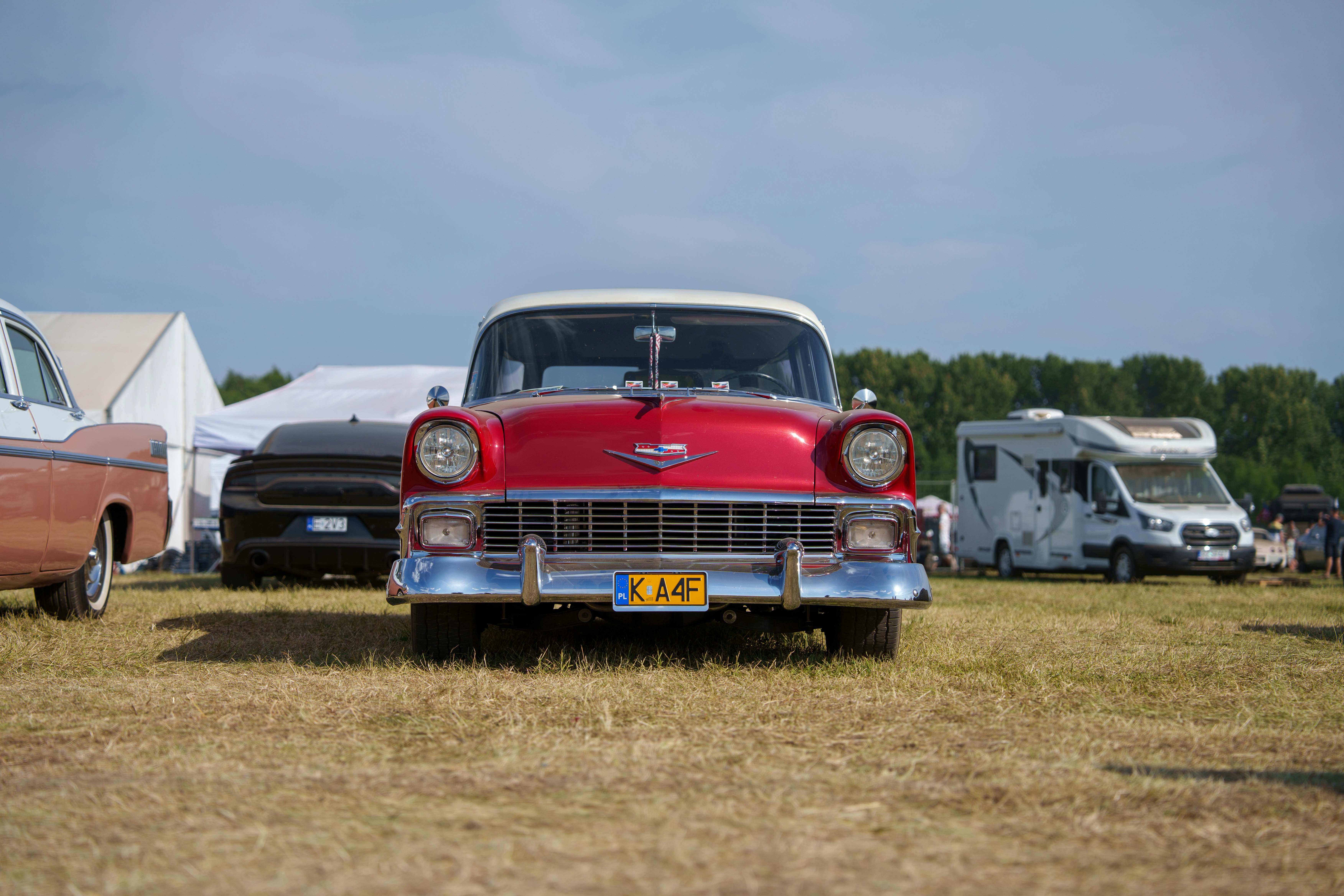 Red Vintage Cadillac Anchored in a Car Show Field