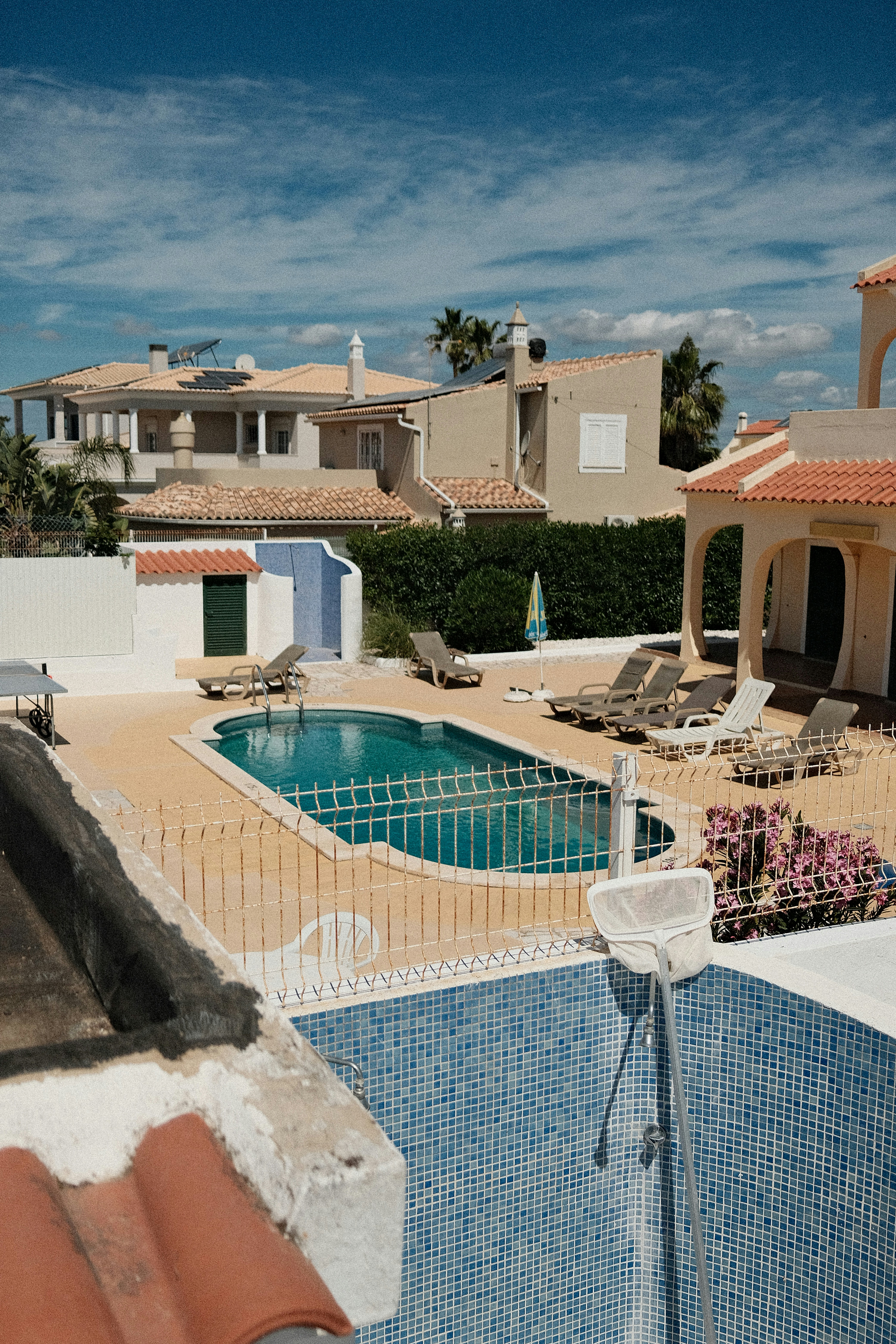 Sunlit Mediterranean Poolscape with Terrace and Houses