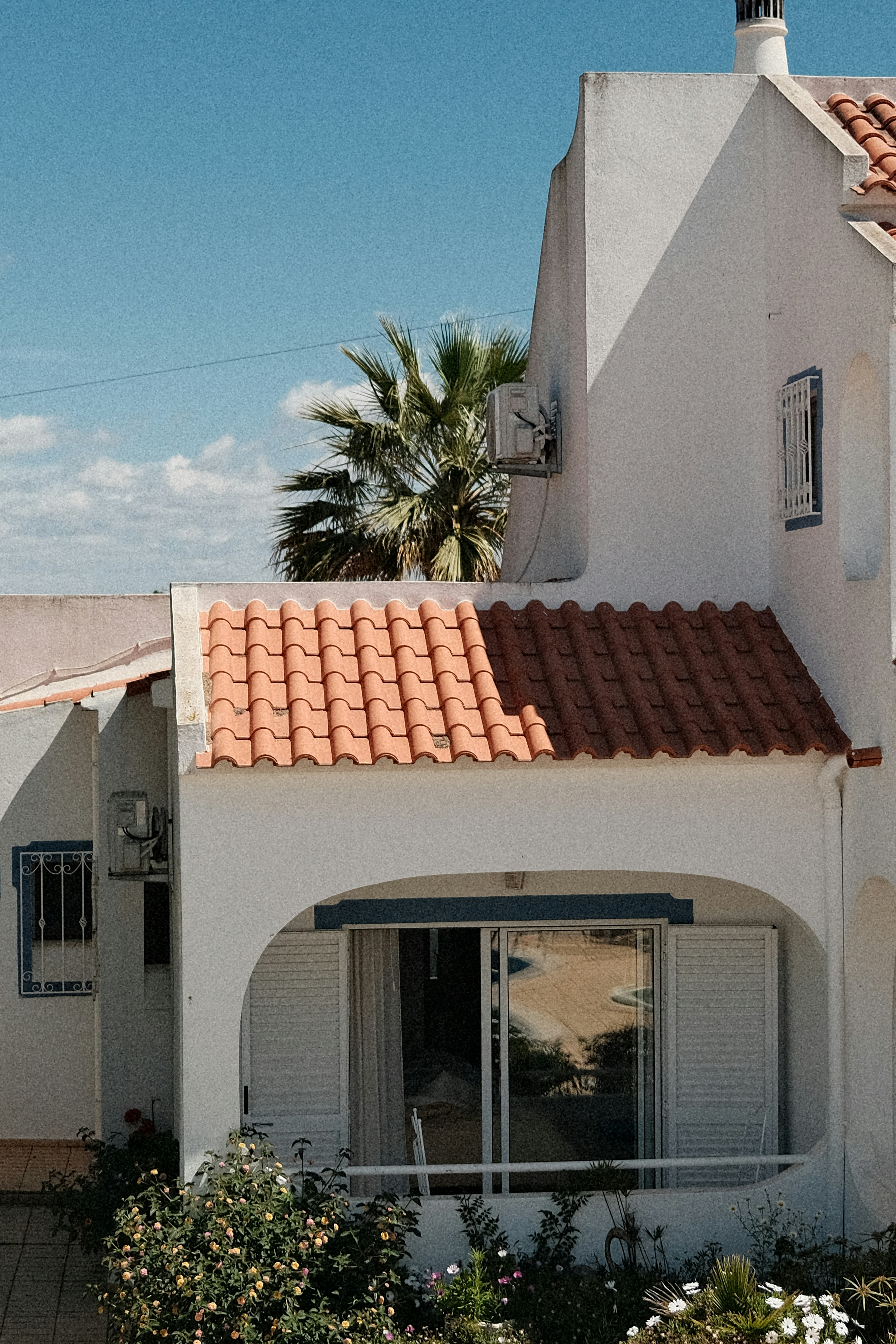 Terracotta Rooflines and Sunlit Archway: A Mediterranean House Portrait