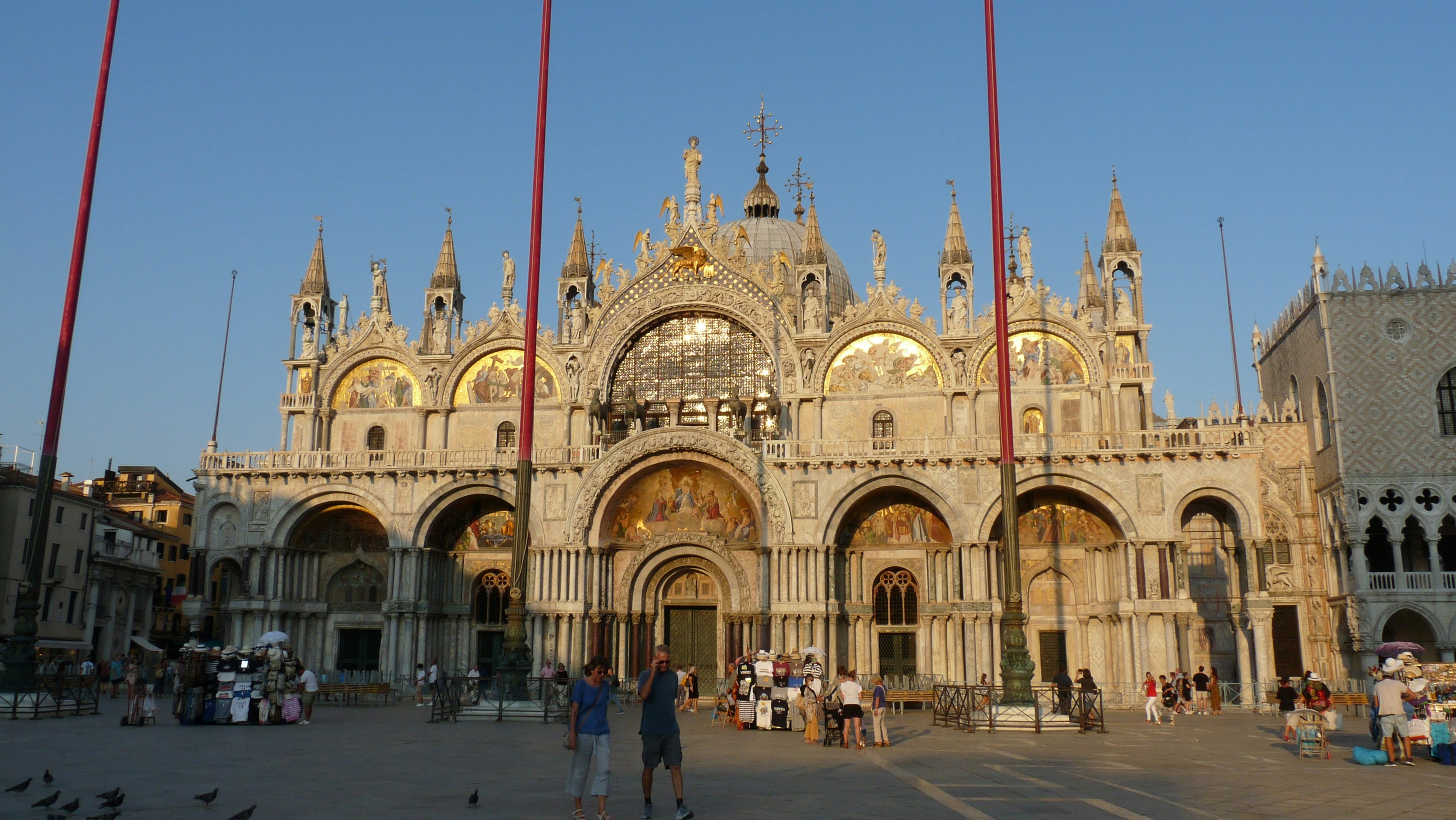 Sunlit Facade of the Basilica di San Marco Under Clear Sky