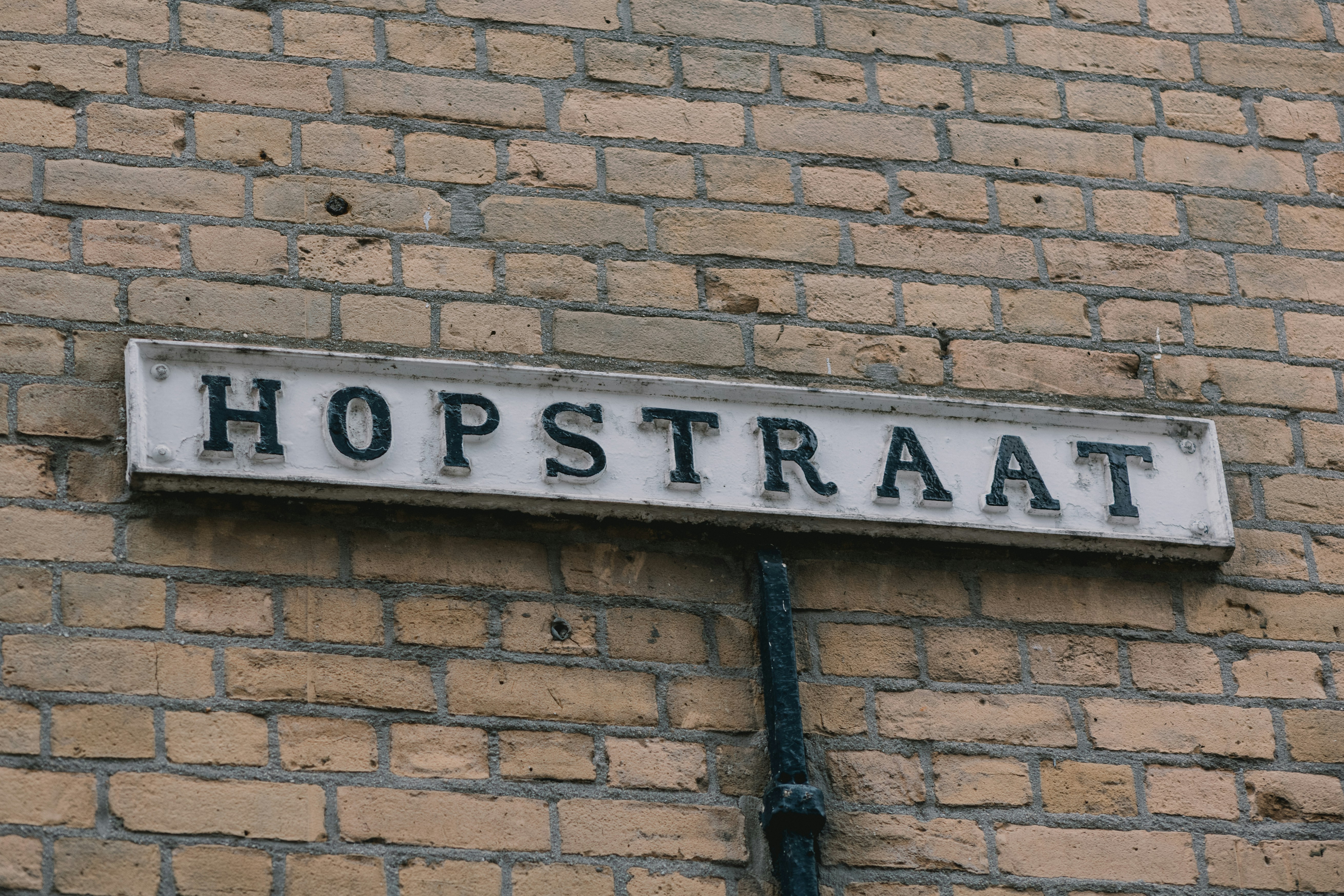 Stone Sign on Sunlit Brick Wall