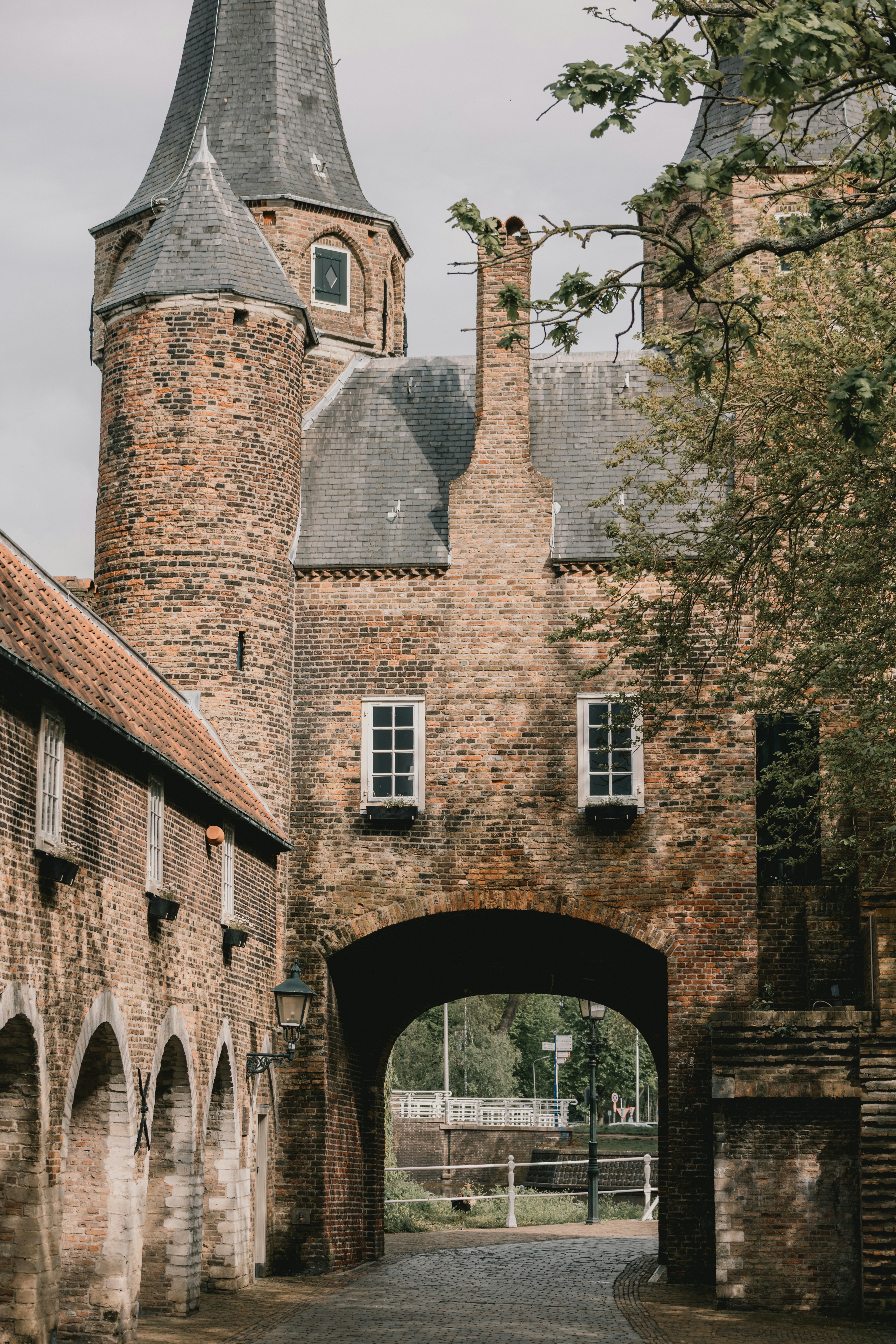Gateway of Brick and Canopy: A Medieval Arch Courtyard