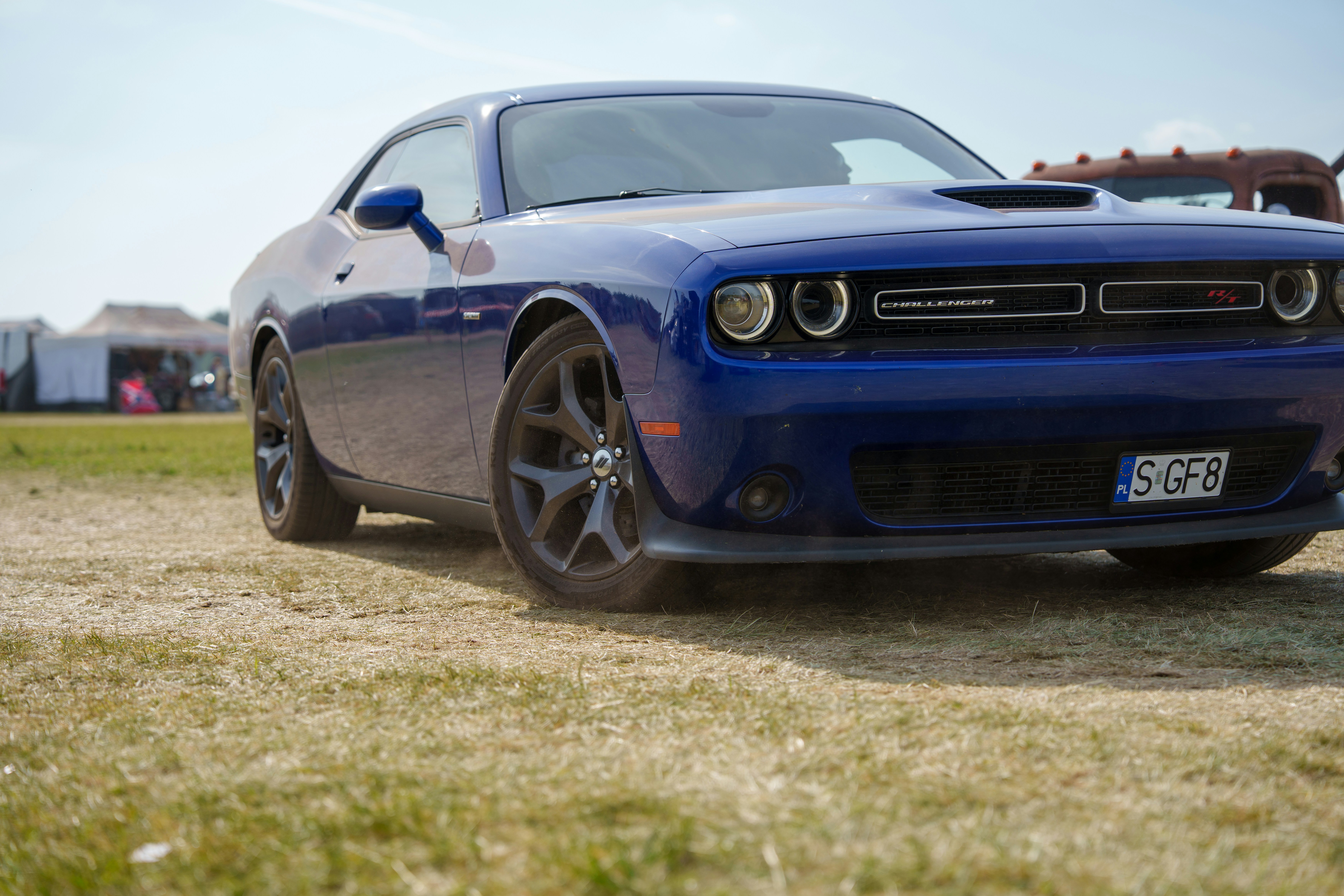 Blue Dodge Challenger Resting on Sunlit Field