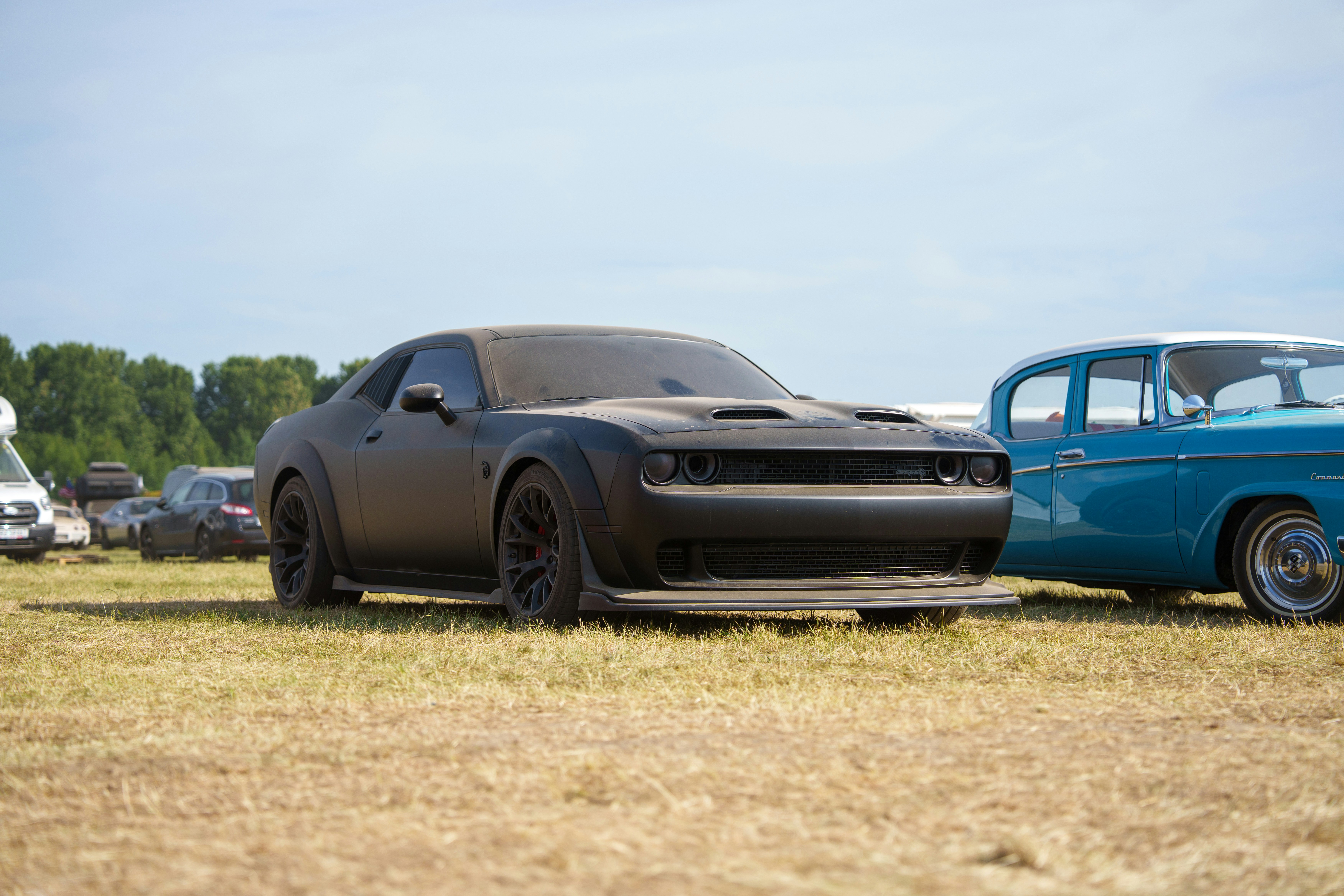 Matte Black Muscle: A Dodge Challenger Amid Classic Carrowd