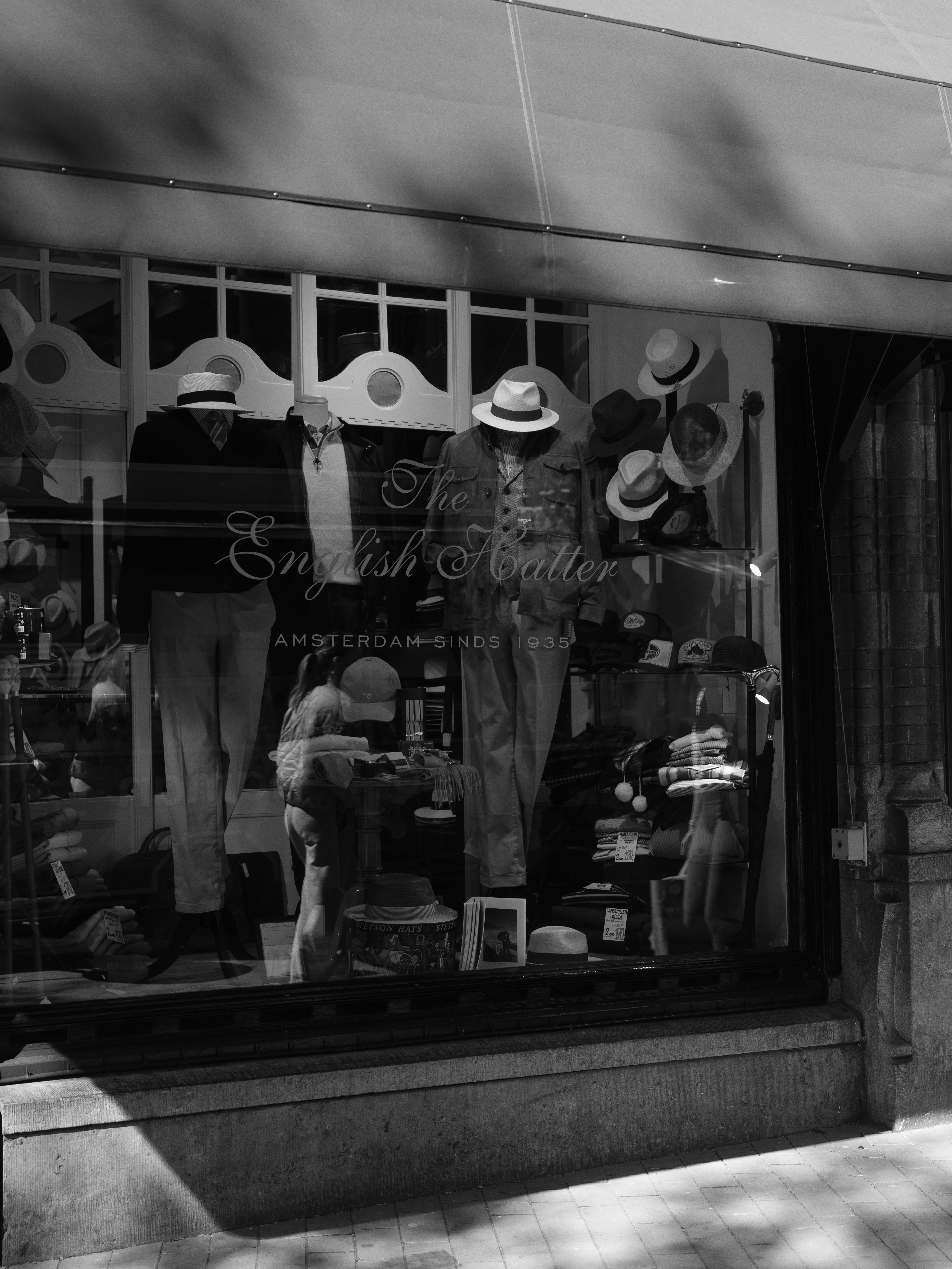 Reflections and Threads: Quiet Storefront in Monochrome