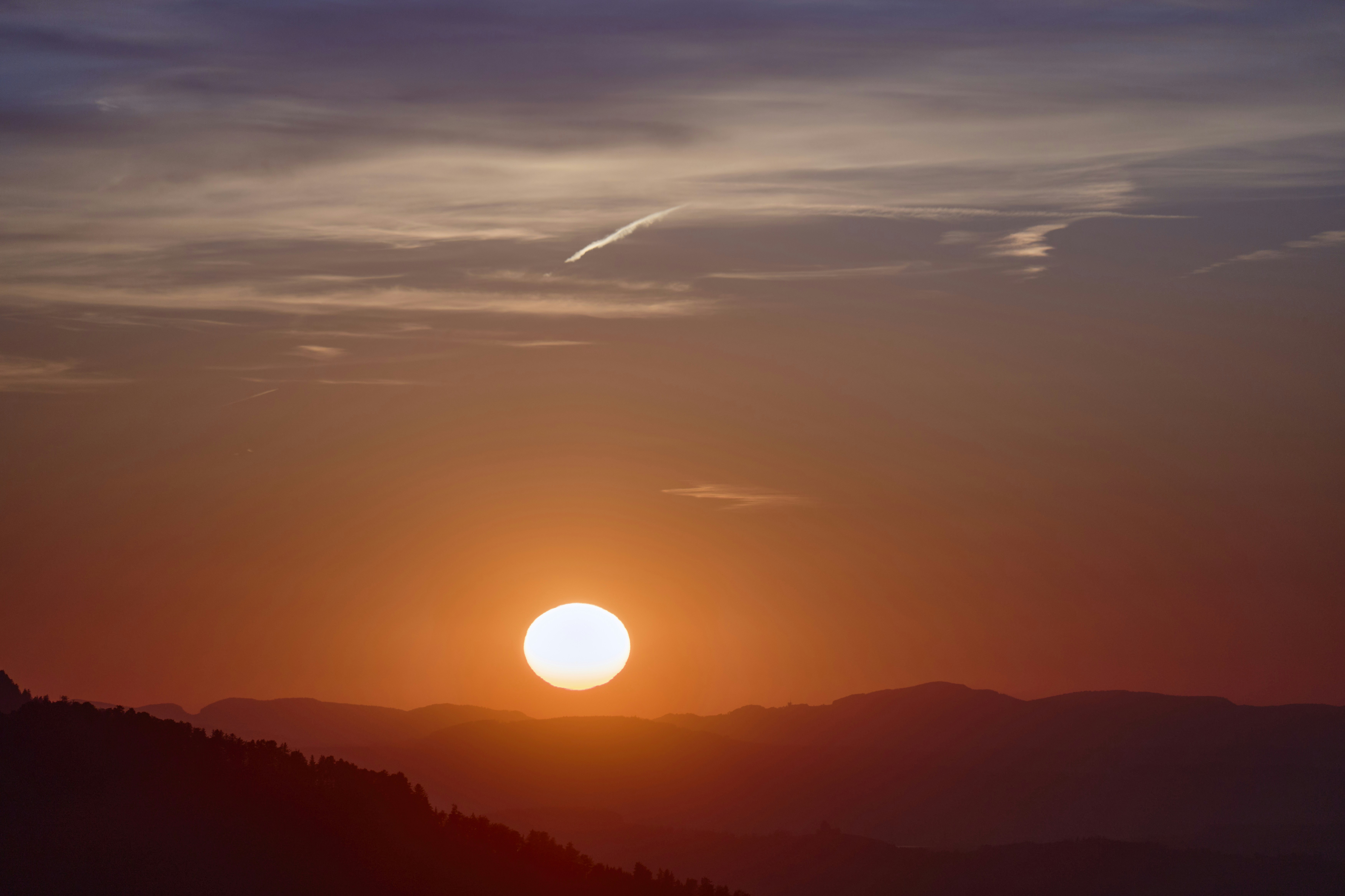 Horizon Fire: A Quiet Sunset Over Rolling Hills