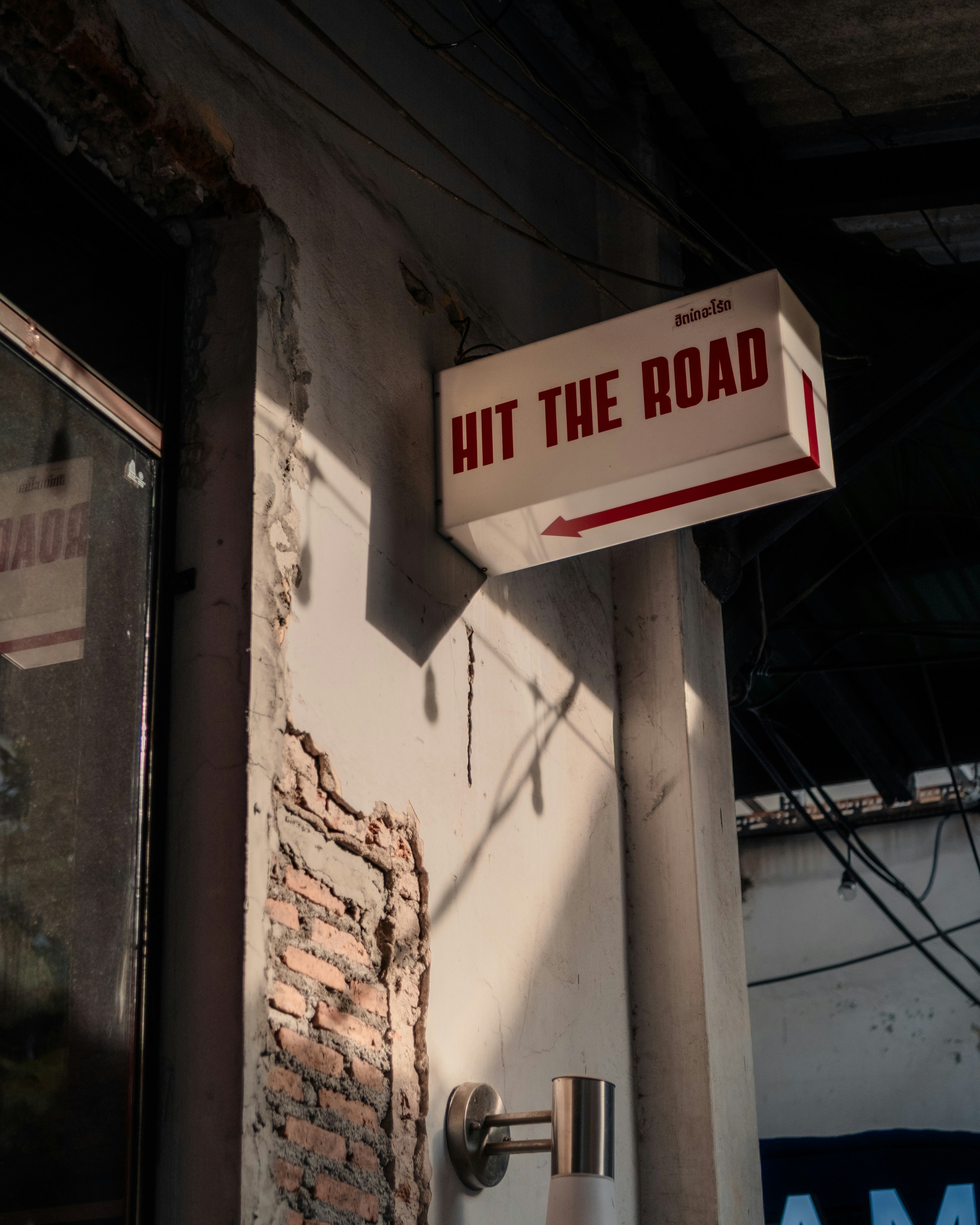 Hit the Road Sign Amid Crumbling Walls