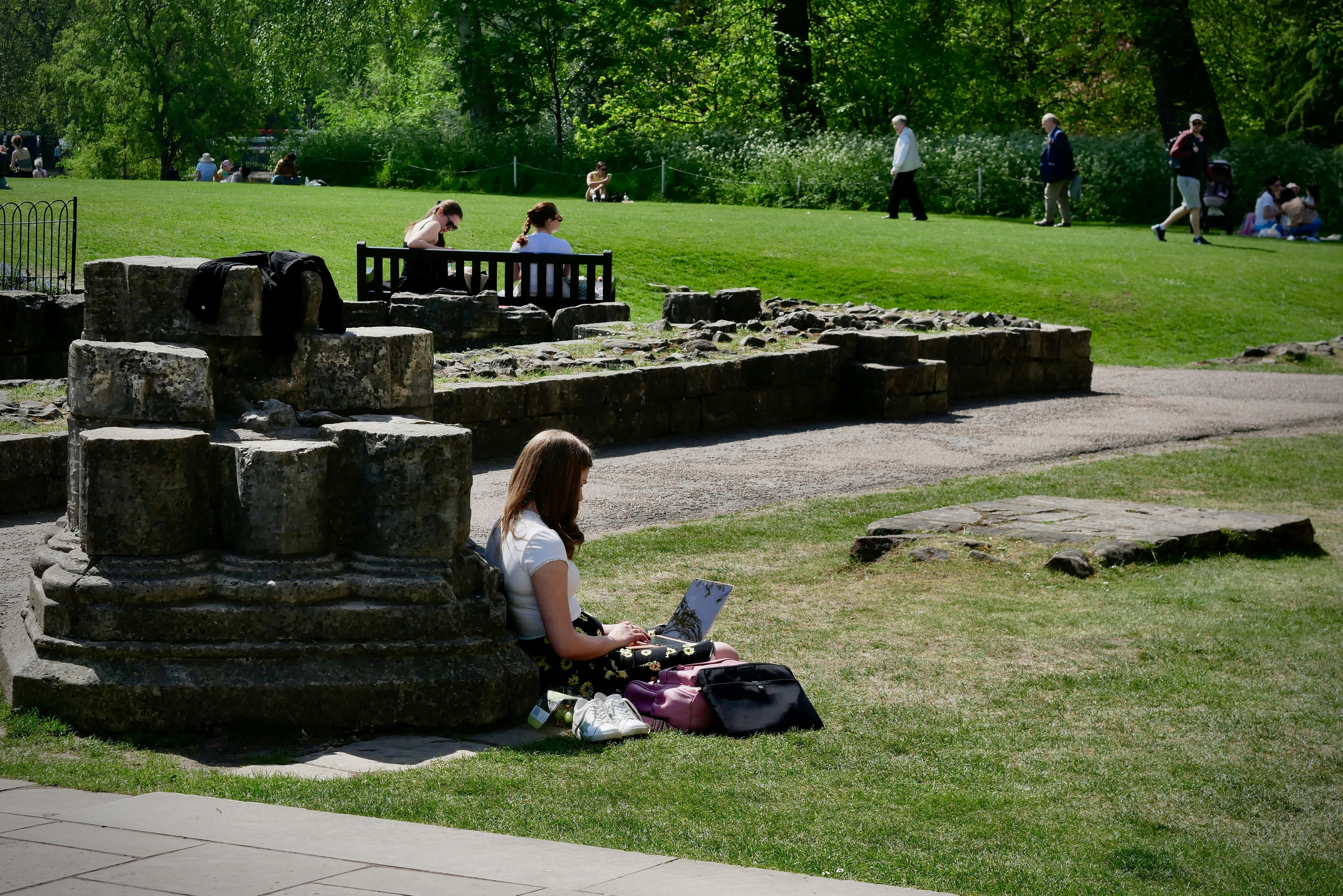 Laptop Quiet in the Park: A Student Finds Focus Among Ruins and Green