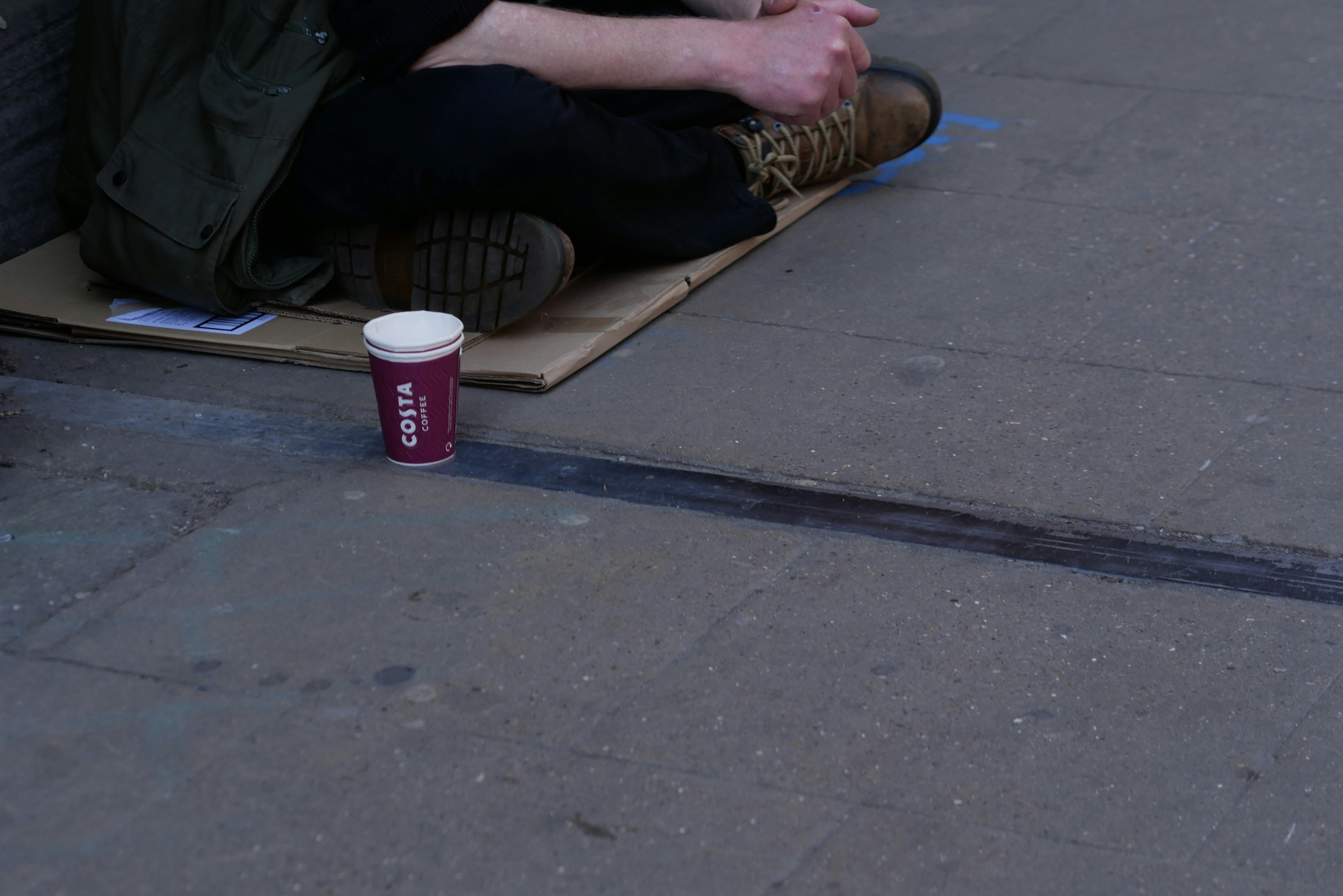 Low-profile vigil: a solitary coffee cup marks the edge of a quiet protest