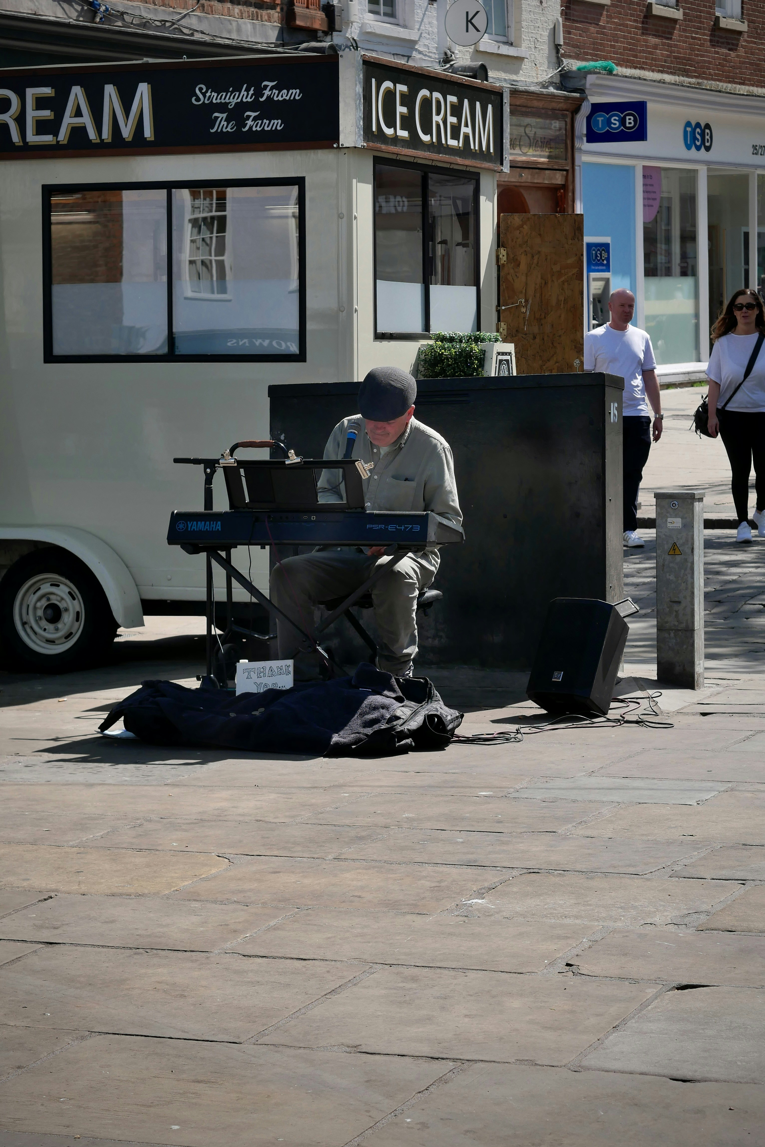 Busking in the street: a pianist under an ice cream kiosk